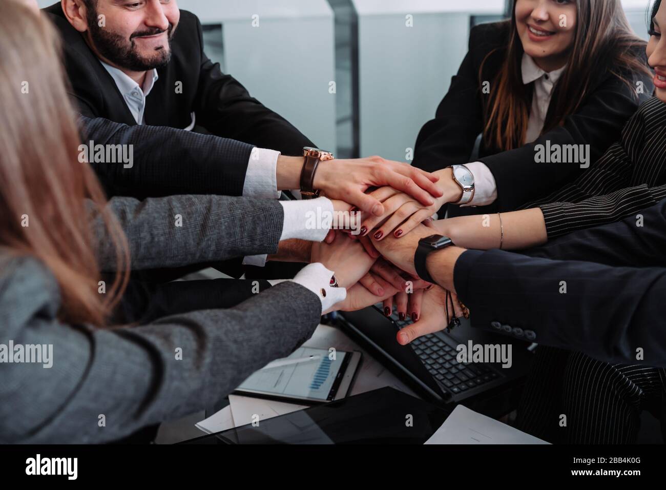 a group of happy colleagues join forces. Creative team, casual business ...