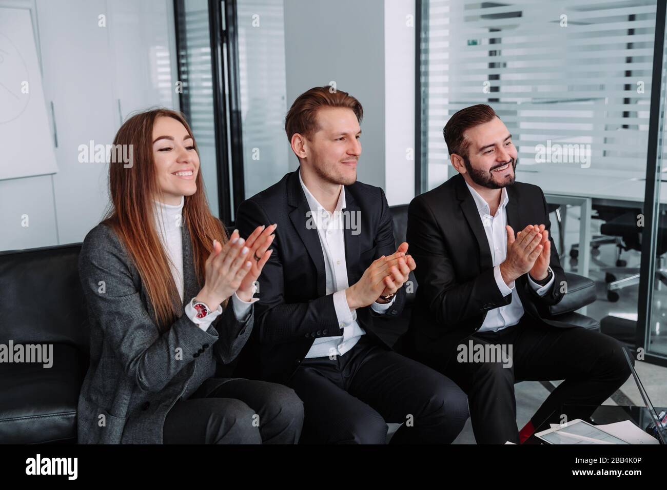 group of business people clapping hands to congratulate their boss ...