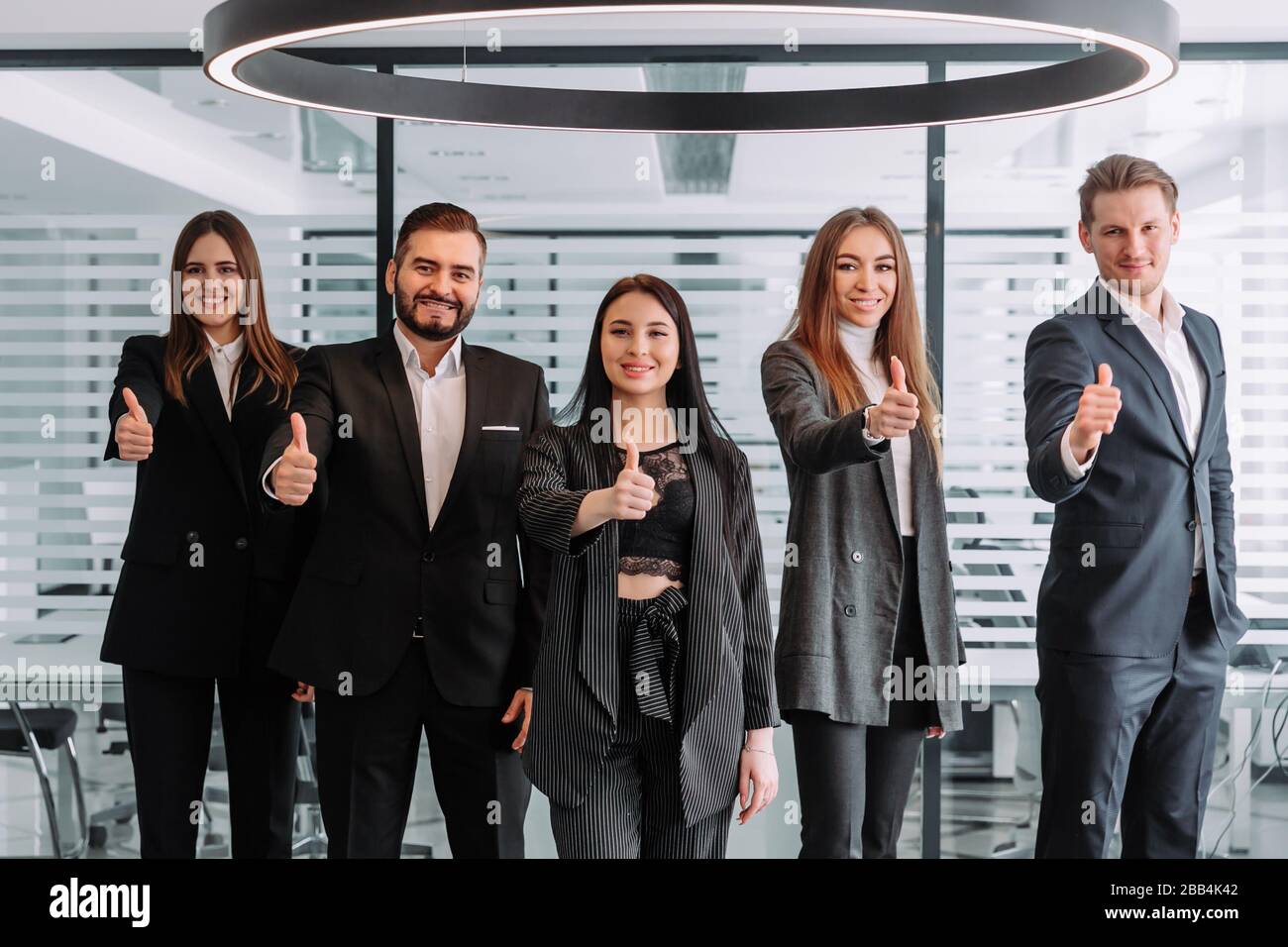 We are successful team Group of cheerful young people standing close to ...