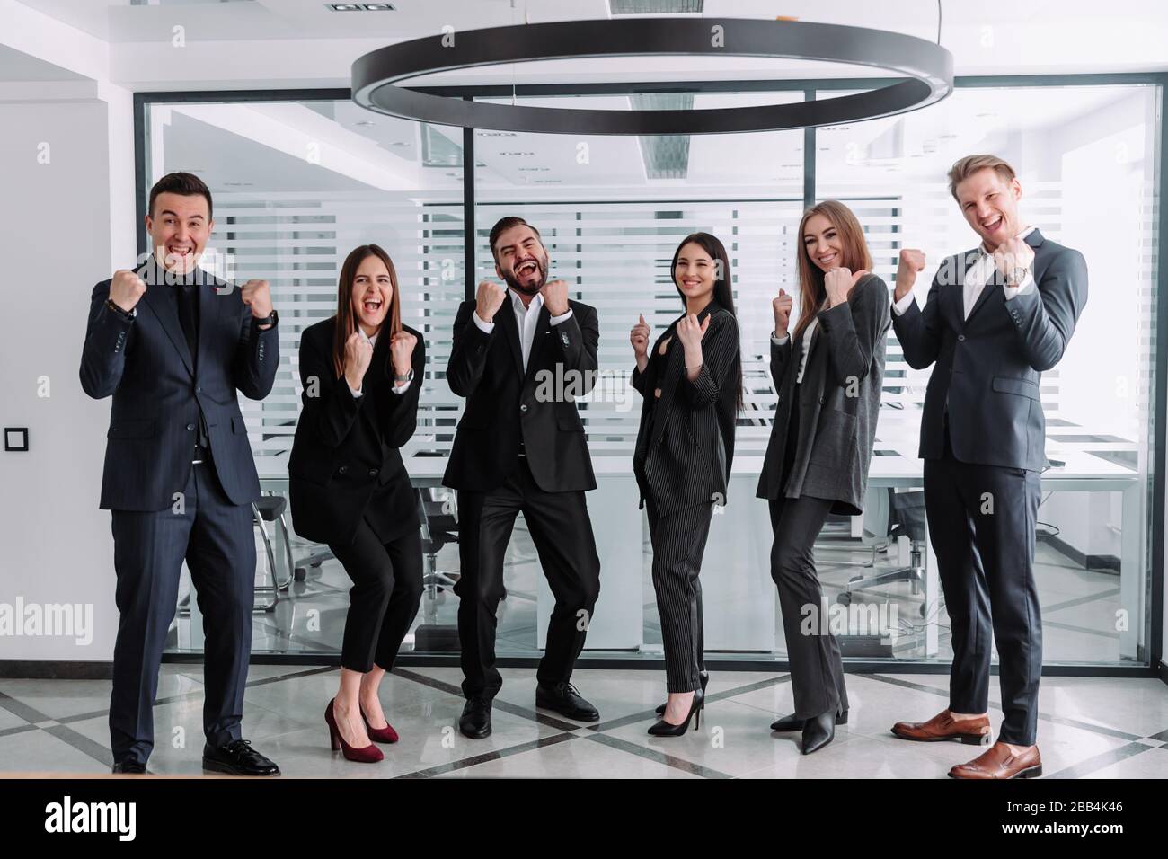 Happy business people celebrate success. A successful corporate team of ...