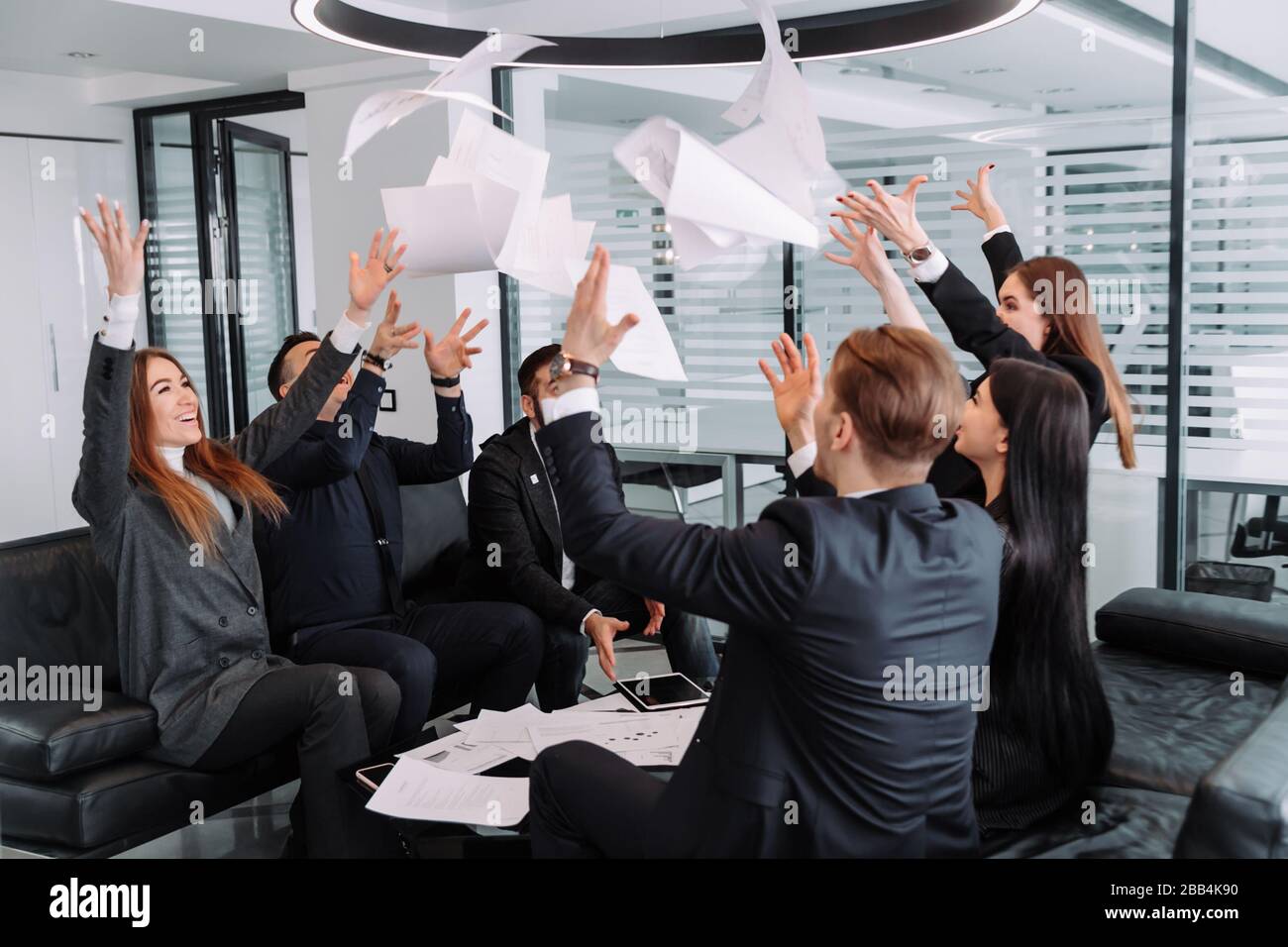 Group of business people celebrating by throwing their business papers ...