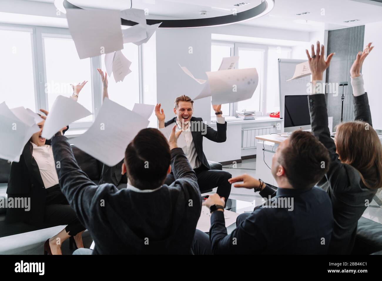 Group of business people celebrating by throwing their business papers ...