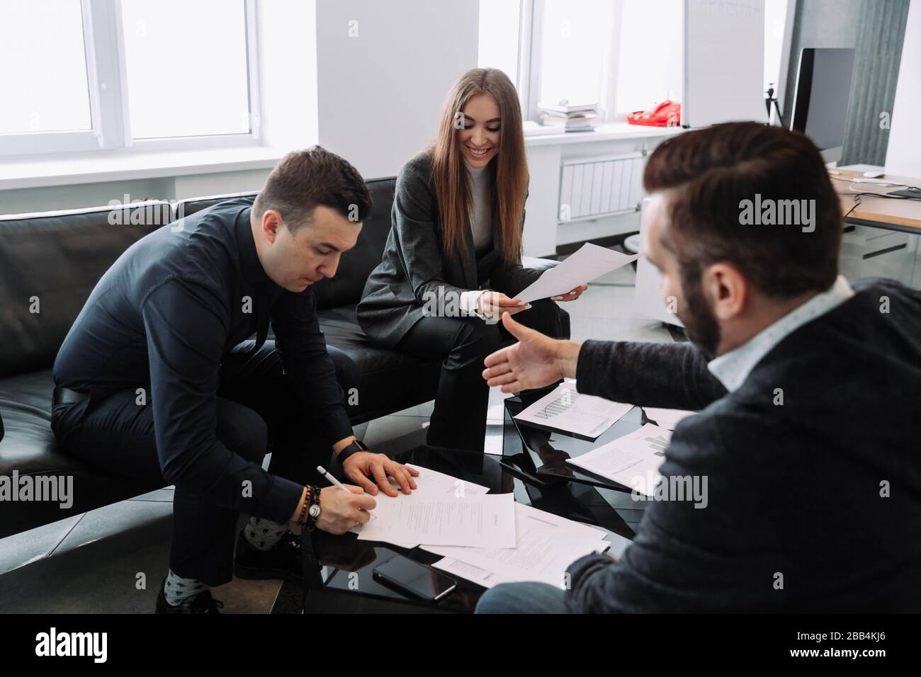 Business partners handshakes after signing the contract,the ...