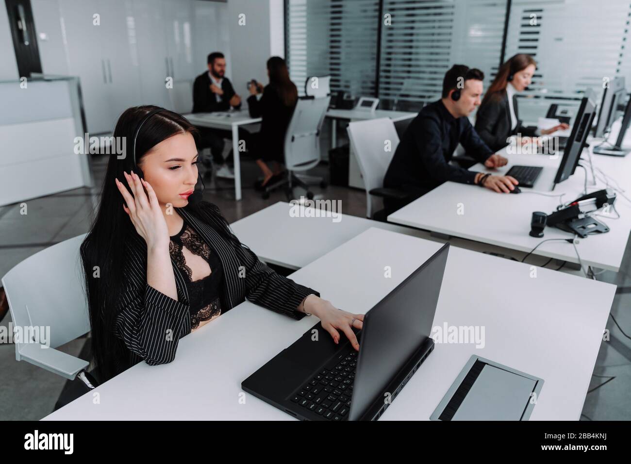 Busy call center operators in a modern office Stock Photo - Alamy