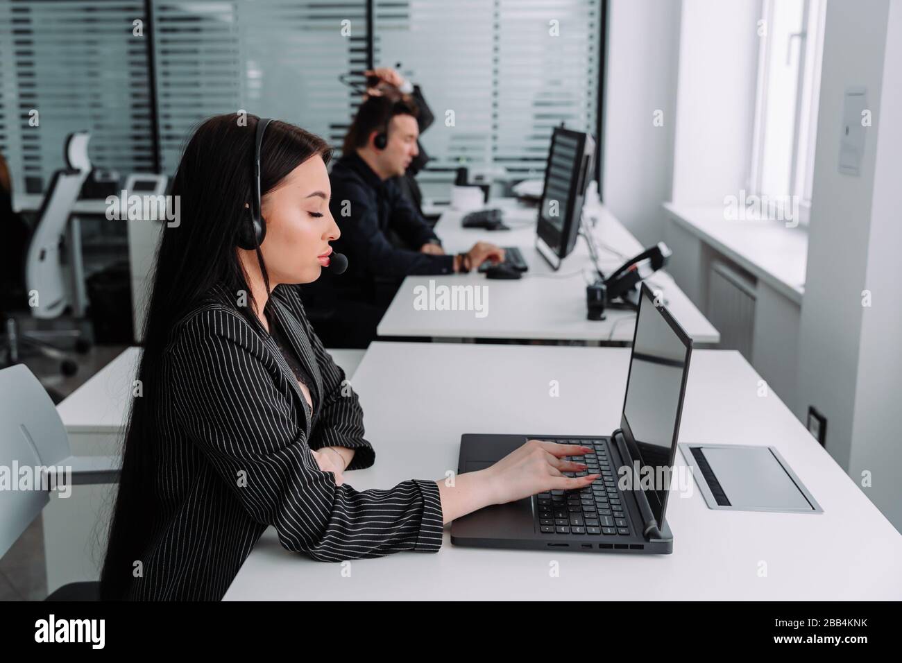 A team of business people working in a call center on the line.Busy ...