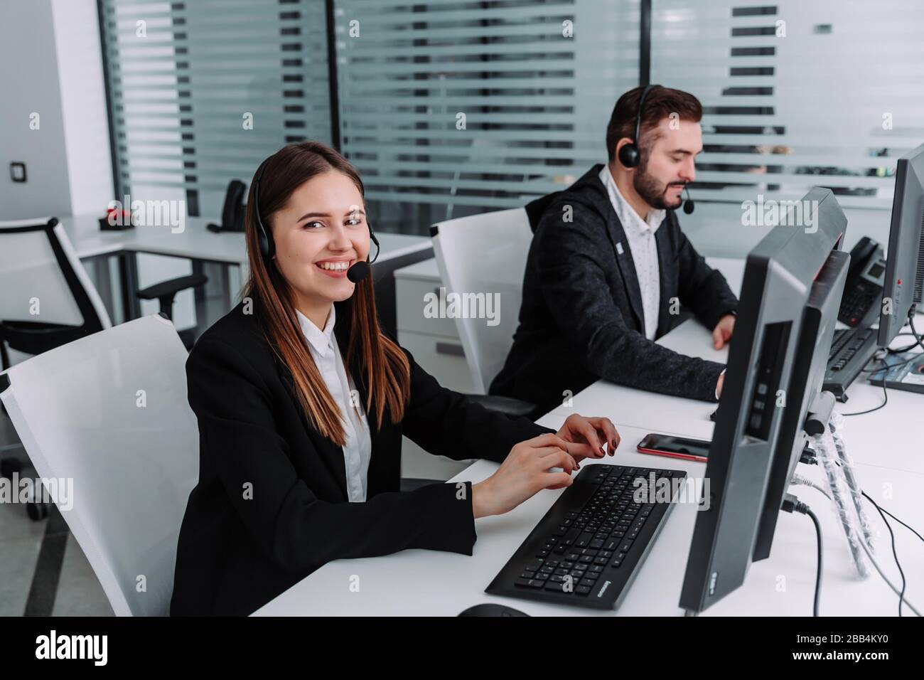 Call center. Focus on the beautiful woman in the headset Stock Photo ...
