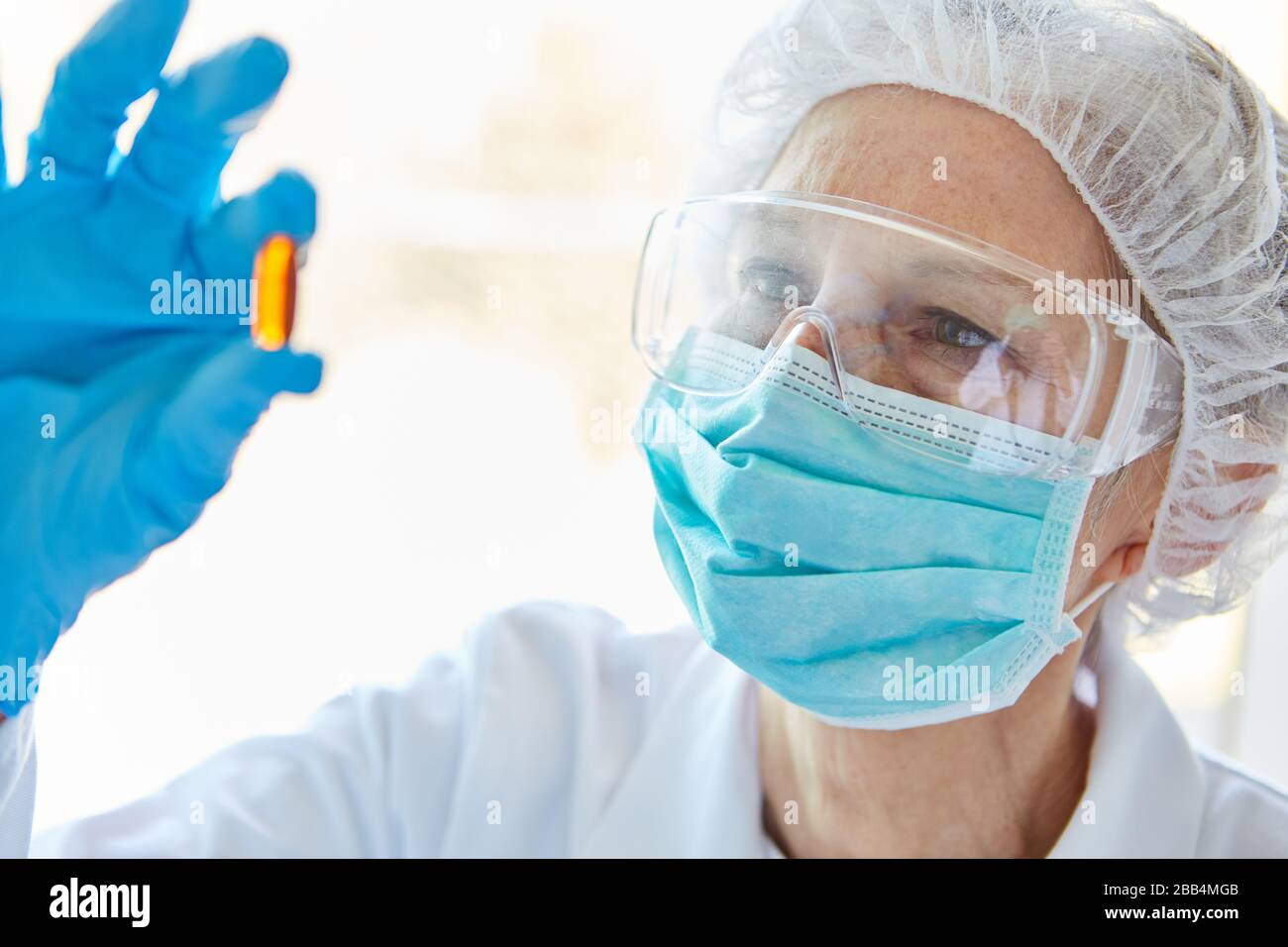 Researchers in protective clothing work on drug against Covid-19 in ...