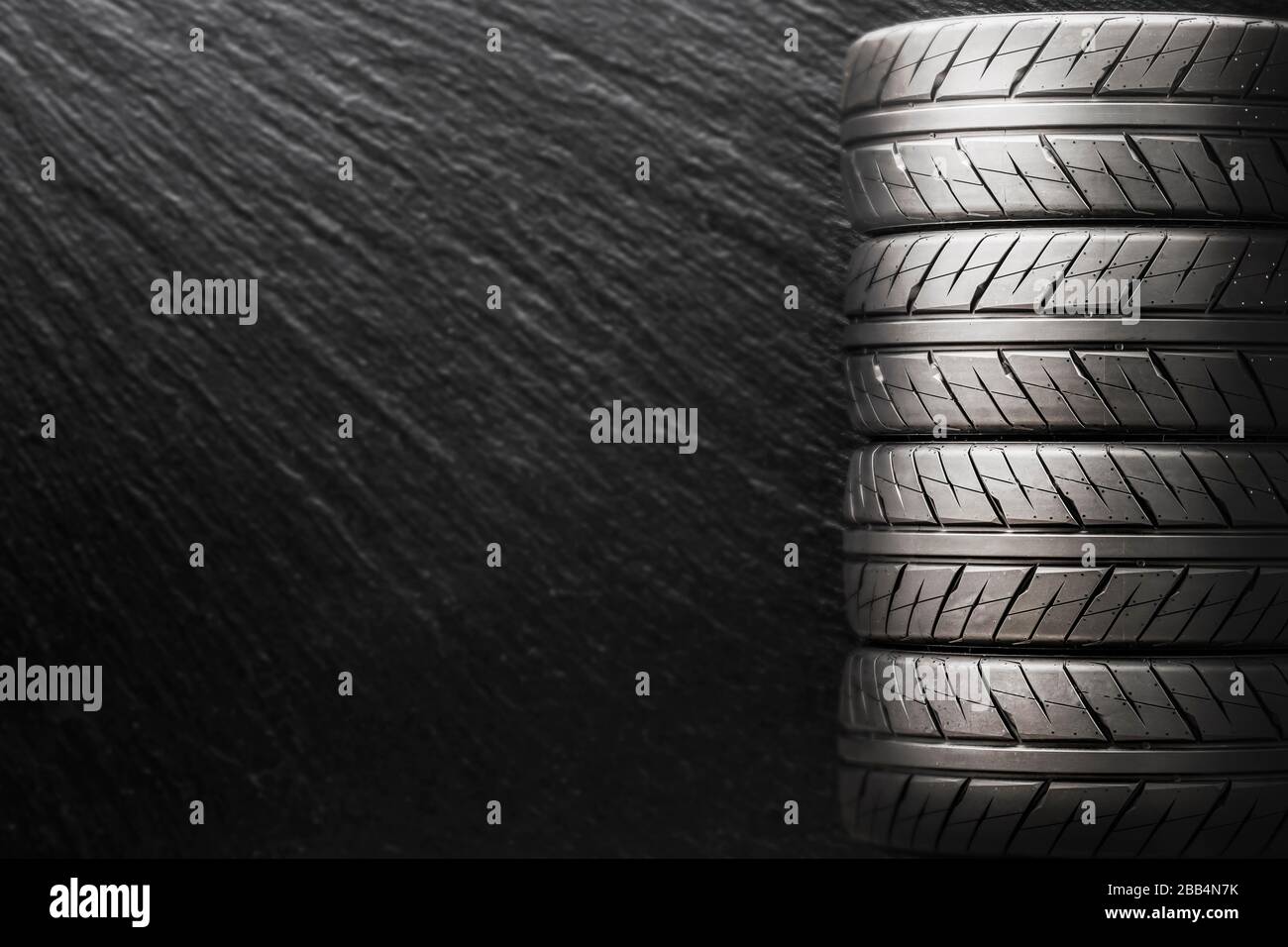 sports tires with a beautiful directional pattern on a dark background ...