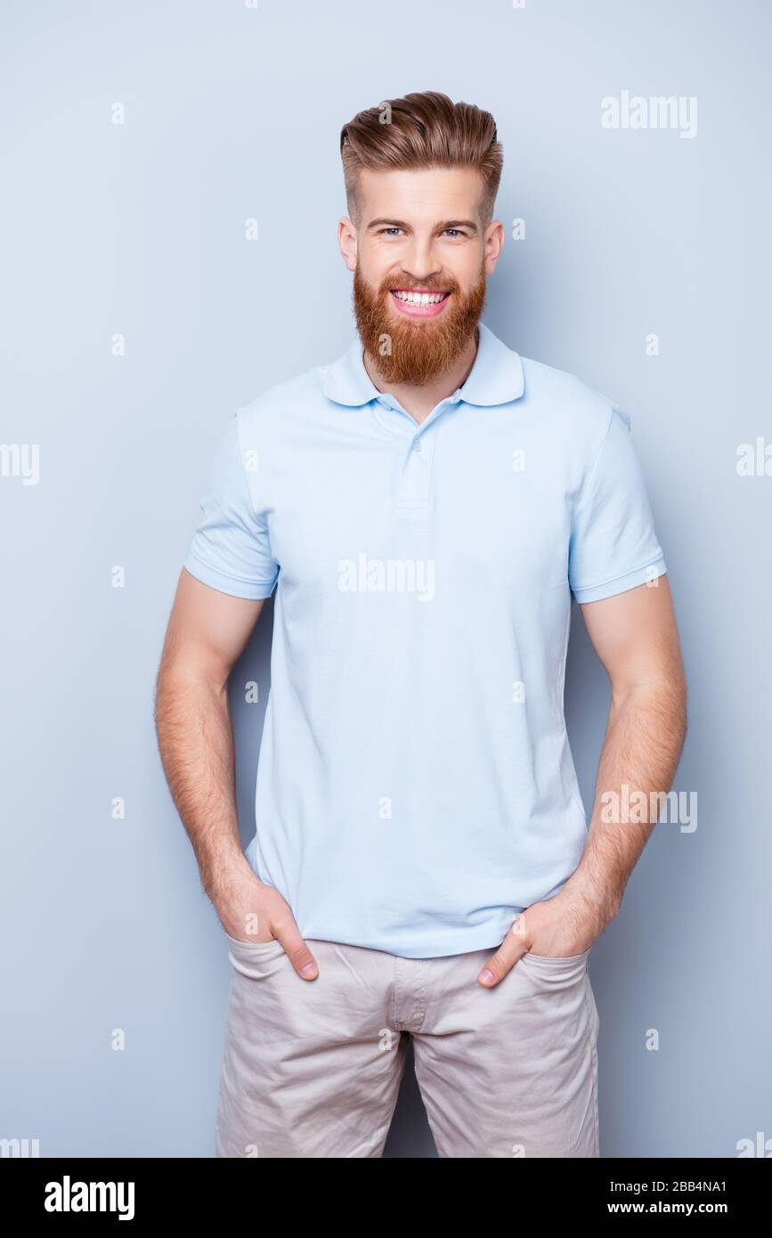 Successful stylish young red bearded man in casual wear is standing on ...