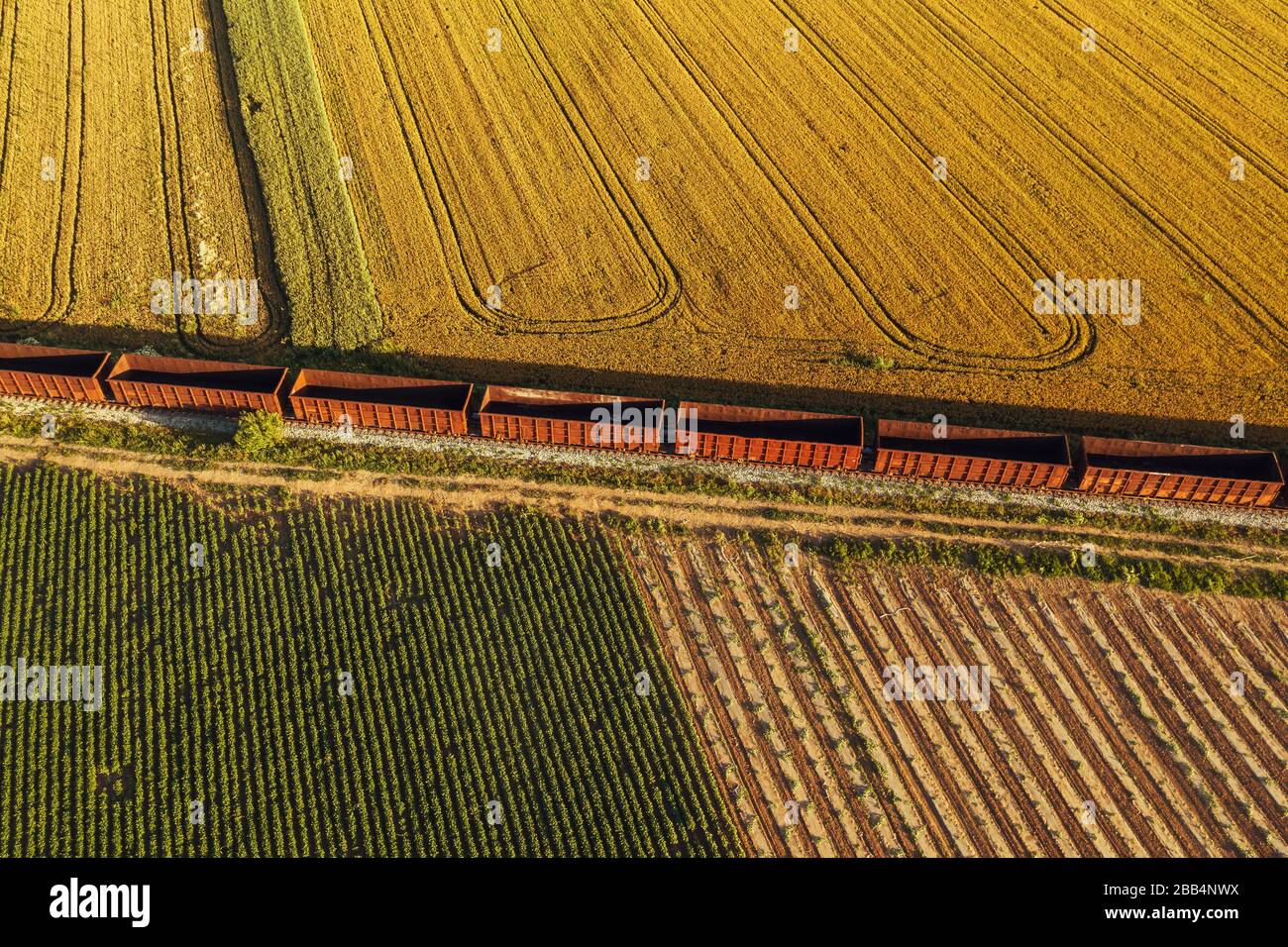 Rail freight transport, aerial view of train passing on railway through ...