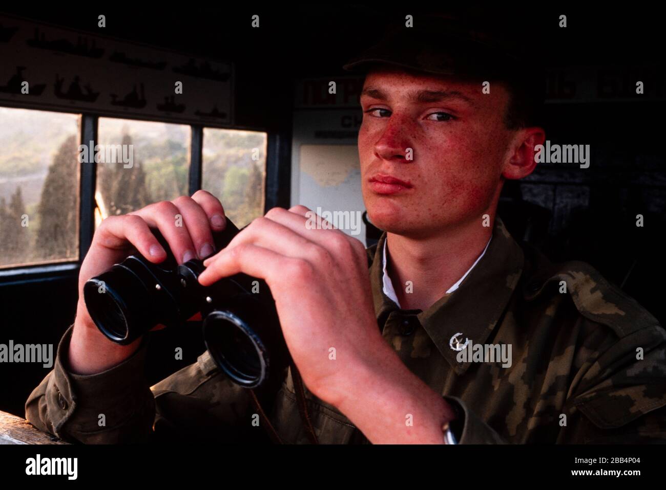 1990 KGB border guard in a lookout post overlooking the sea at Gursfuv ...