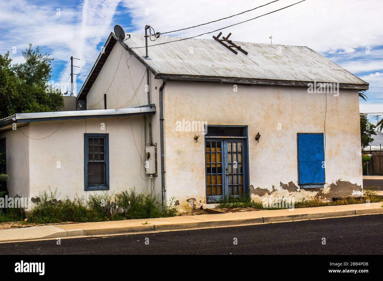 Old Stucco House With Boarded Up Windows And Doors Stock Photo - Alamy