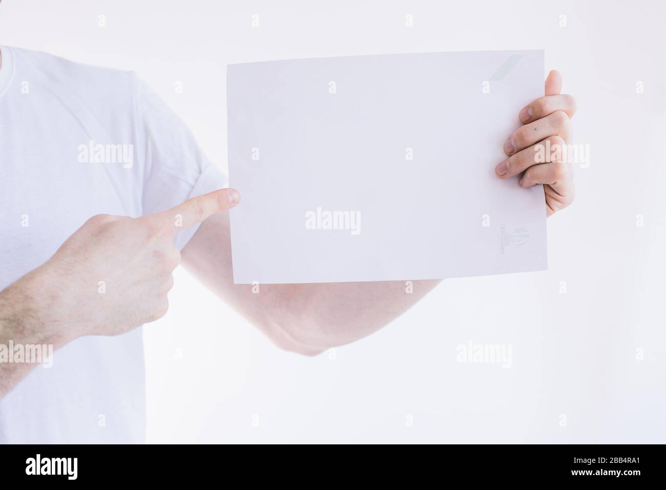 Bearded man holding a blank white sheet of paper. Angry young guy ...