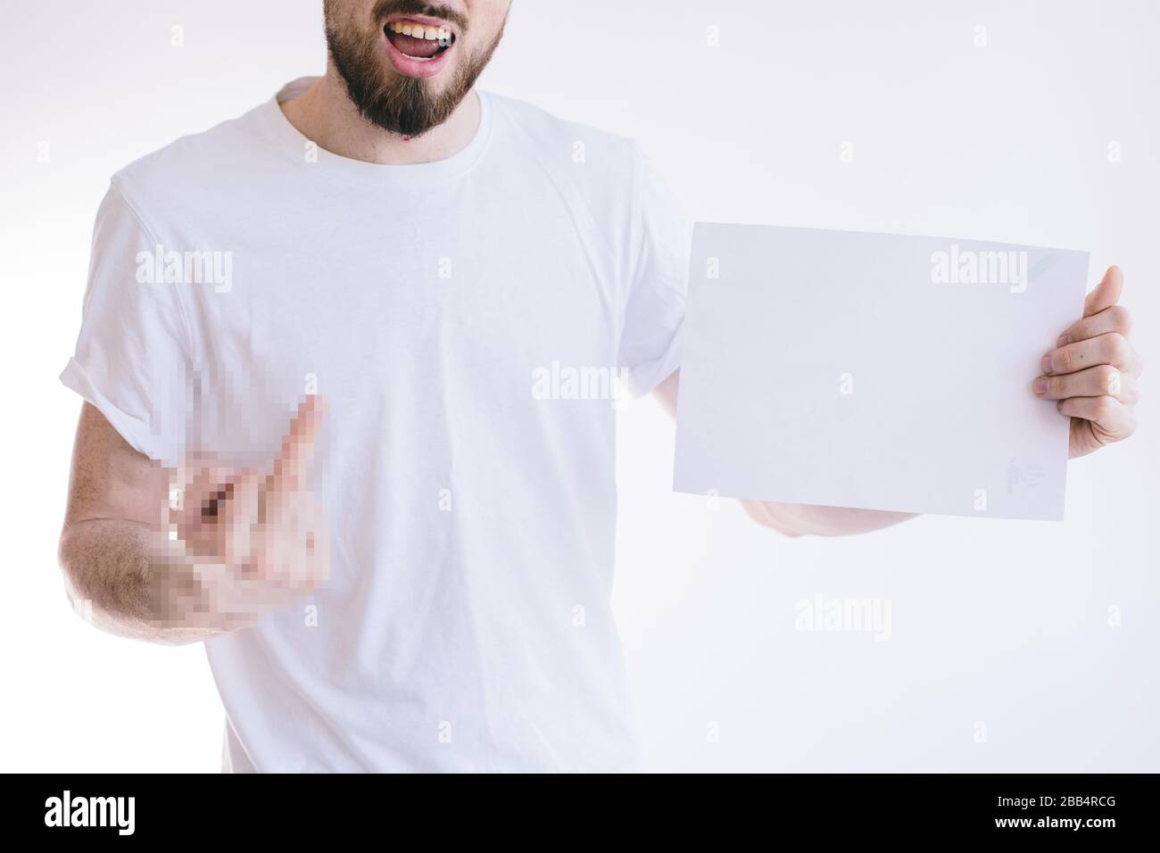 Bearded man holding a blank white sheet of paper. Angry young guy ...