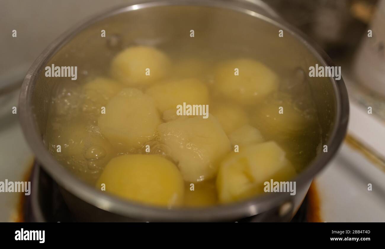 Potatoes cooking in pot at kitchen. Selective focus Stock Photo - Alamy