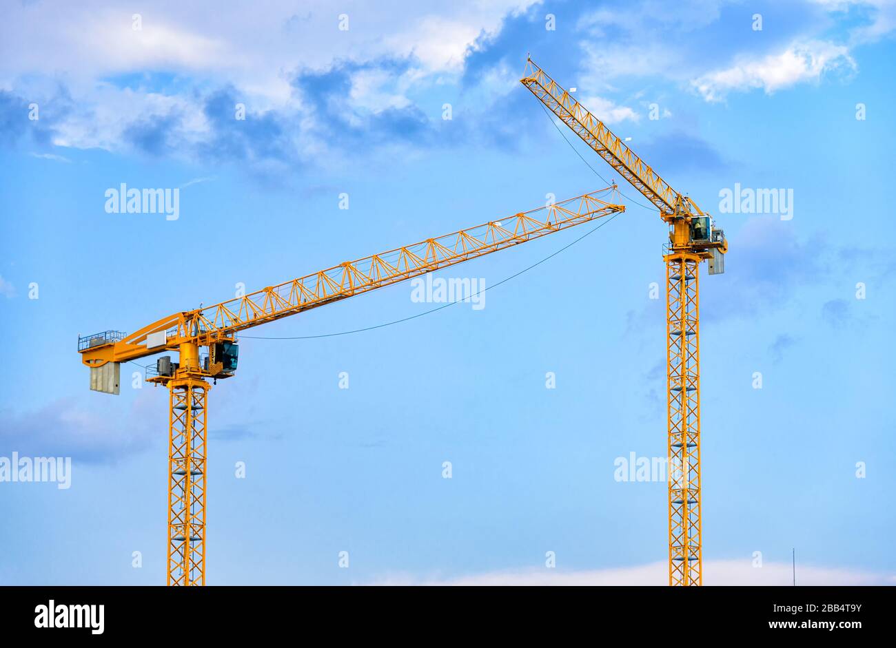 Construction cranes over blue hi-res stock photography and images - Alamy