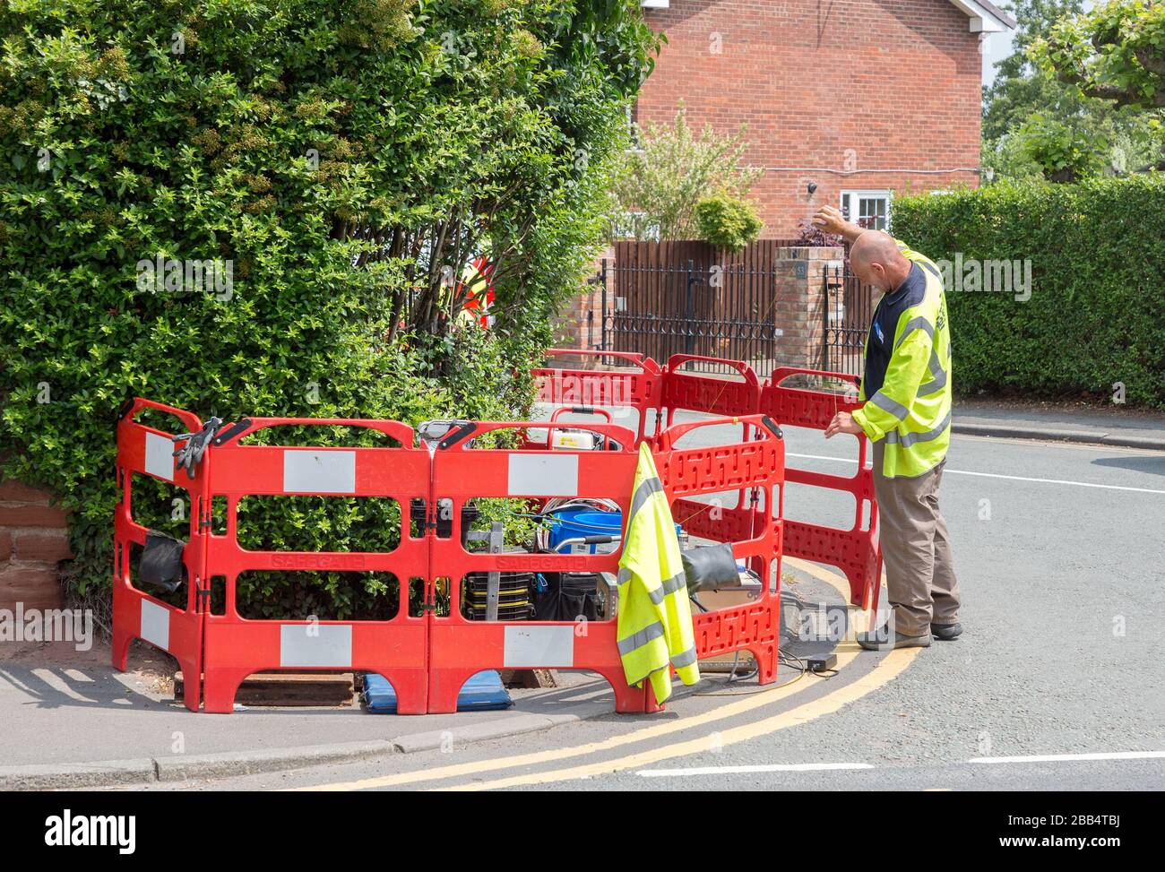 Worker pulling string through underground pipe, Chester, Cheshire ...