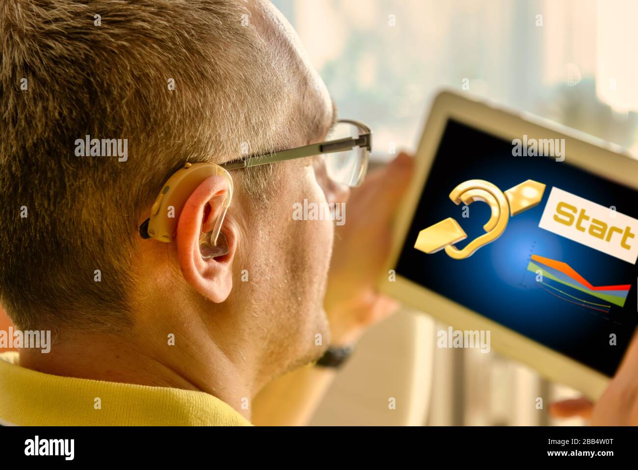 Man wearing deaf aid in ear with tablet showing deaf sign an the ...