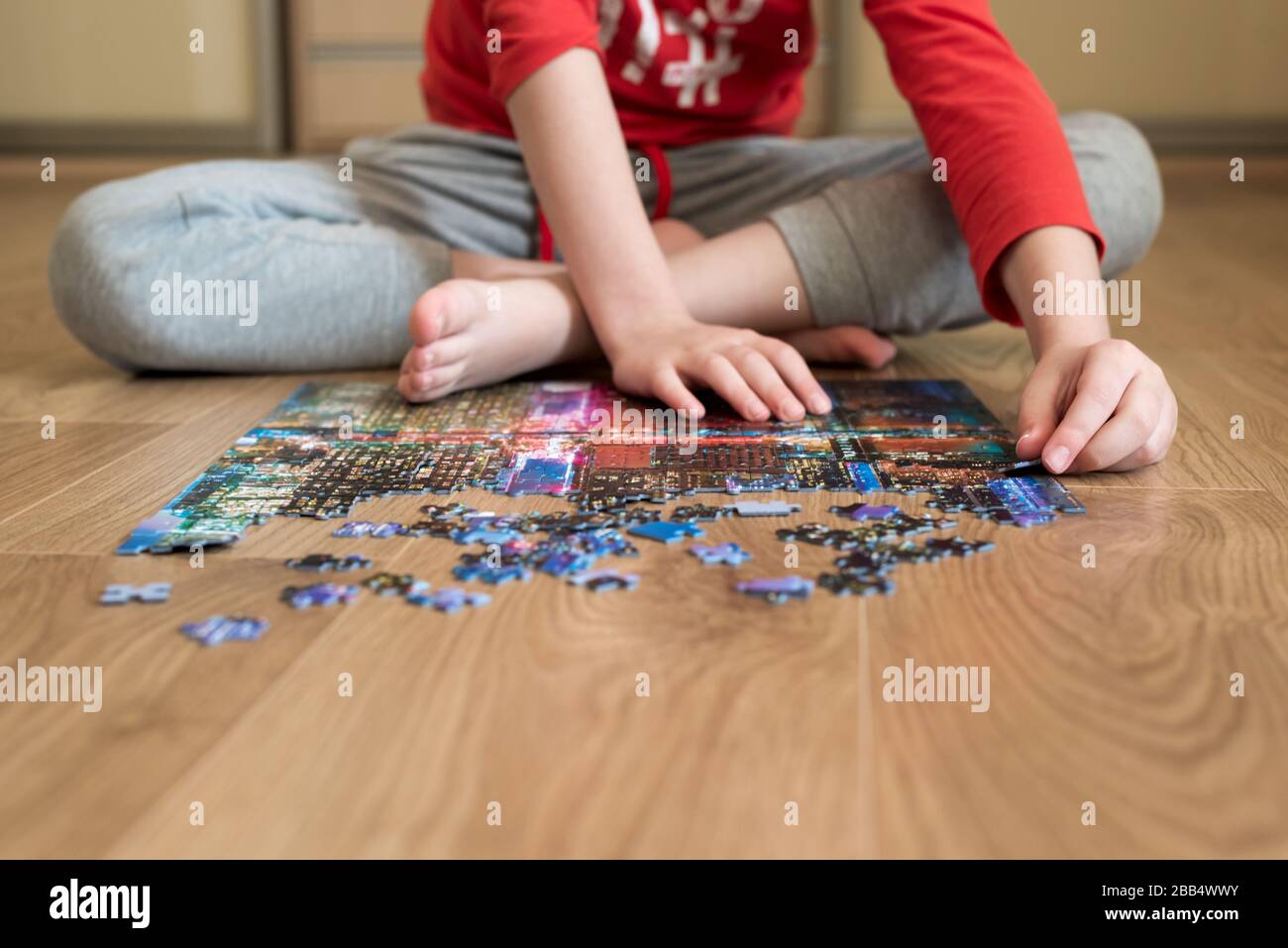 Boy collect puzzle sitting on the floor. Solving difficult tasks or ...