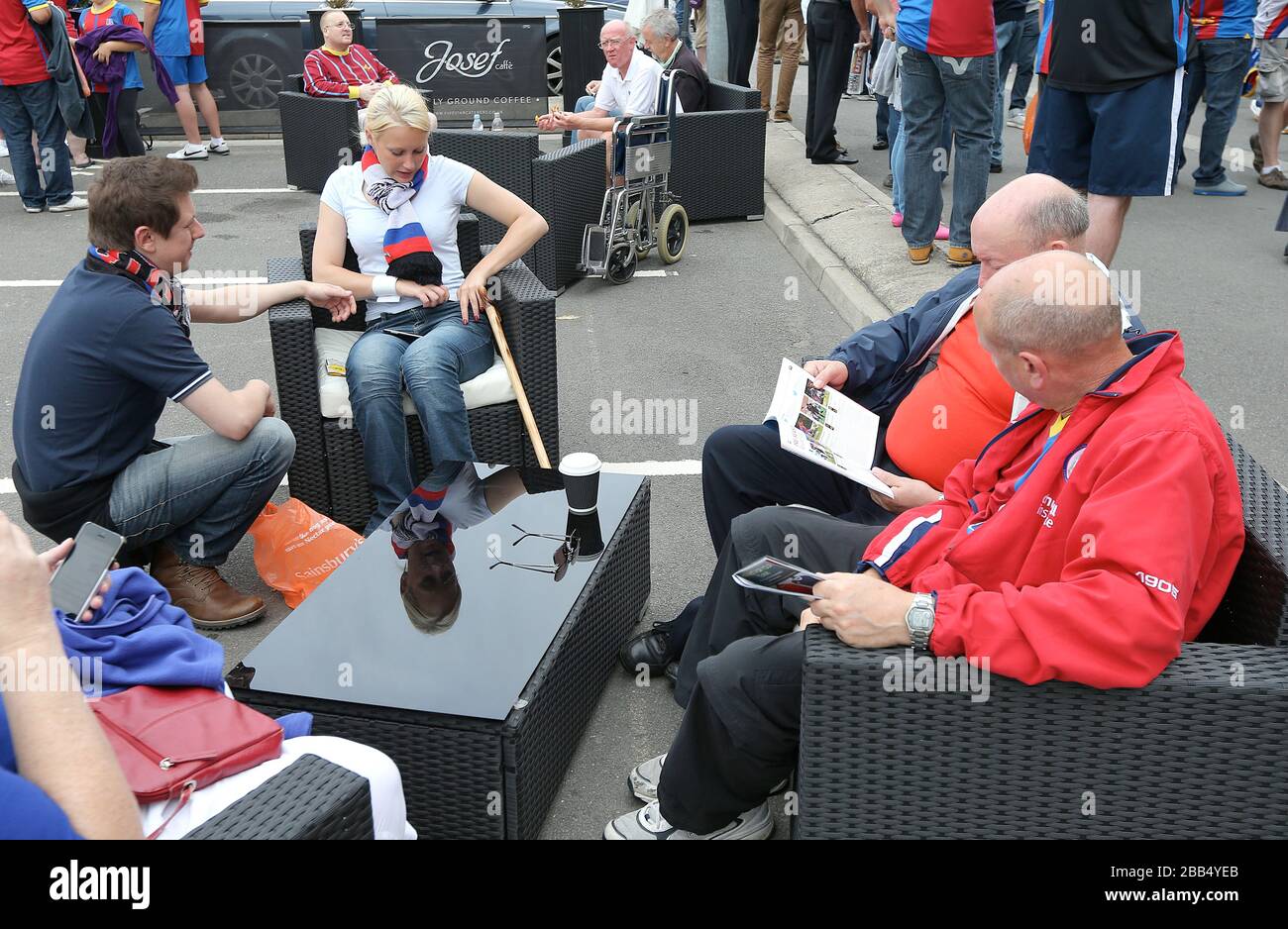 Fans sit in chairs and enjoy a drink outside Selhurst Park before the ...