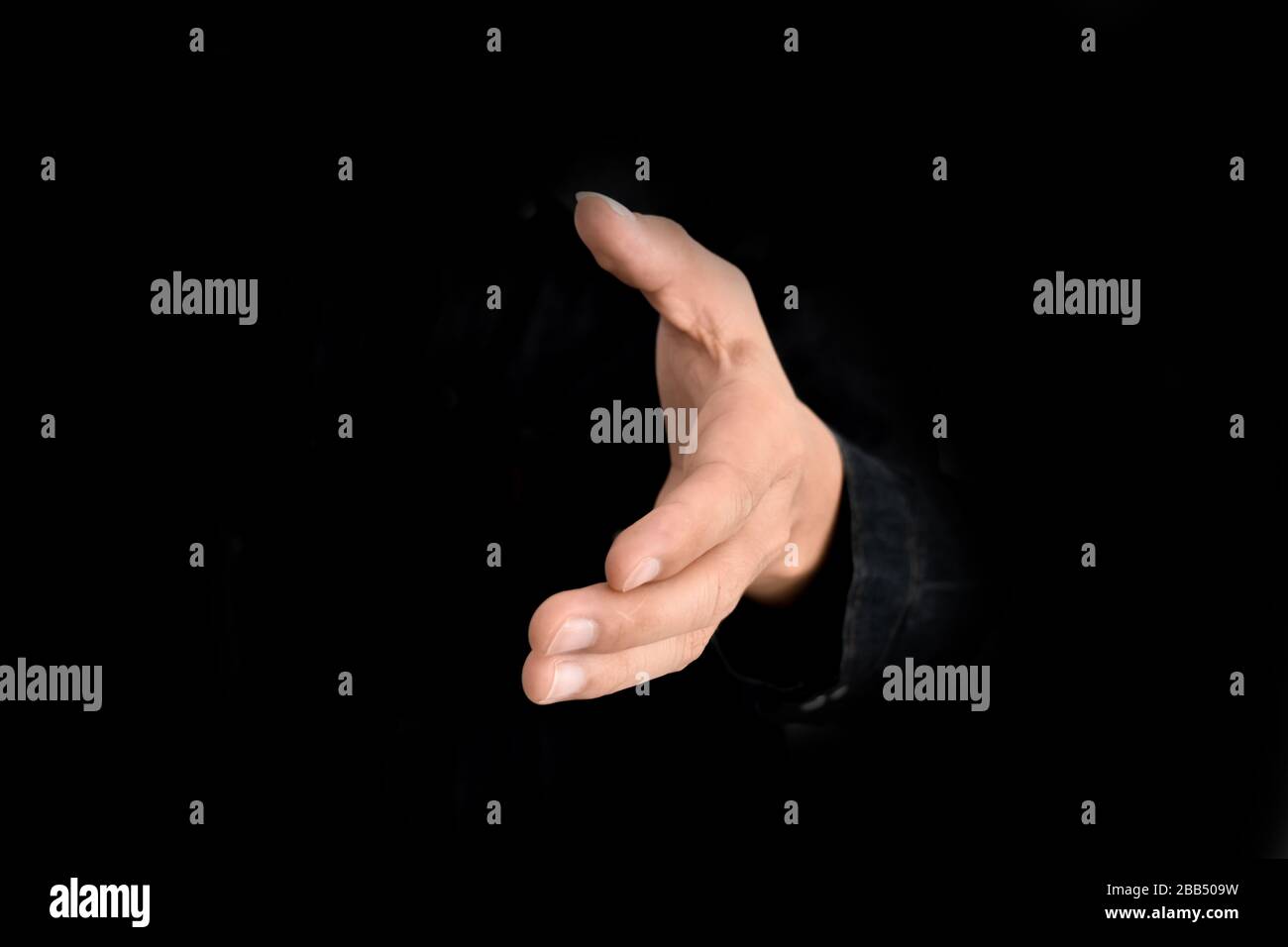 Businessman offer hand for handshake and cooperation over black ...