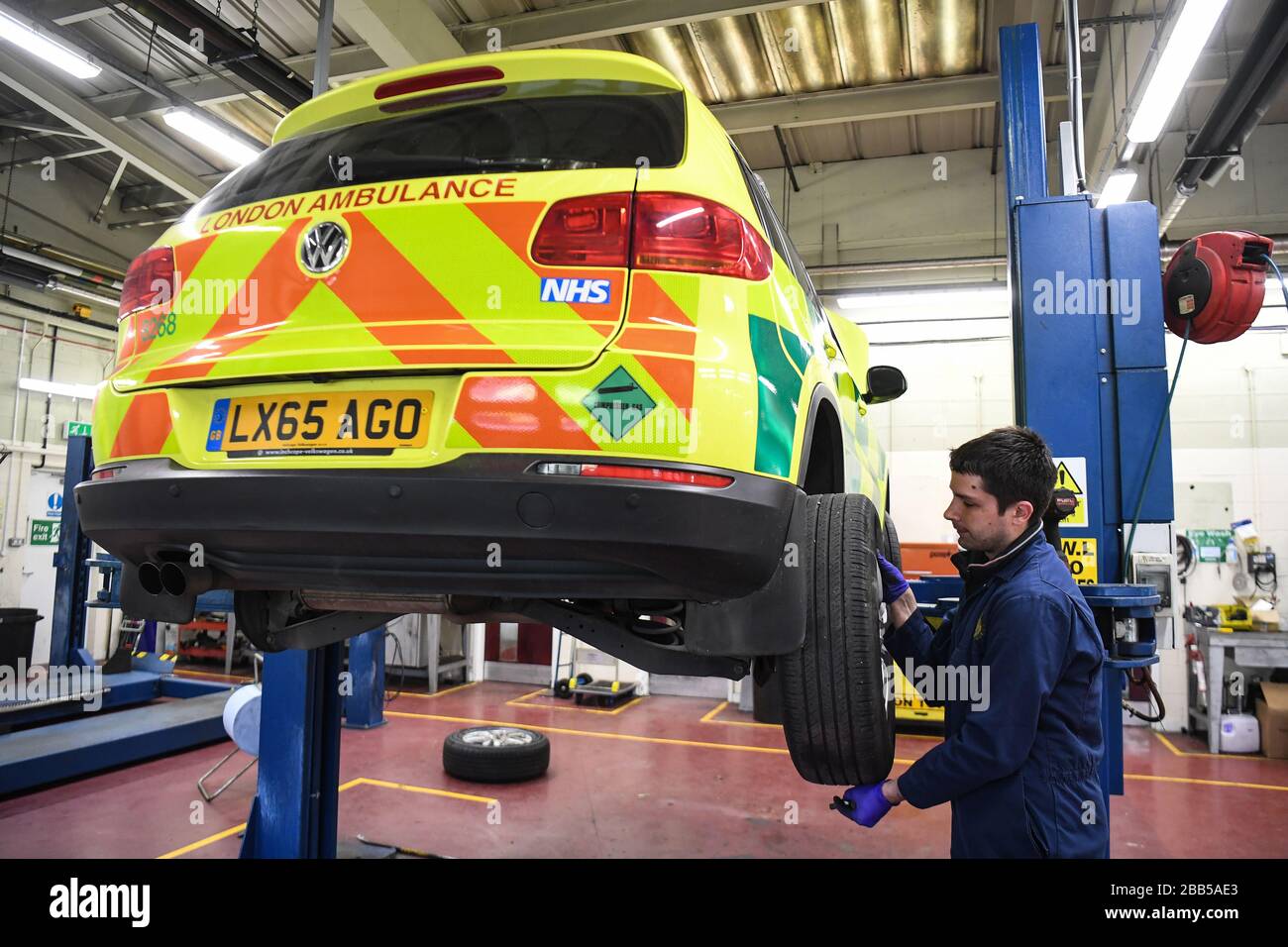 Embargoed to 0001 Tuesday March 31 An NHS mechanic takes a tire off an ...