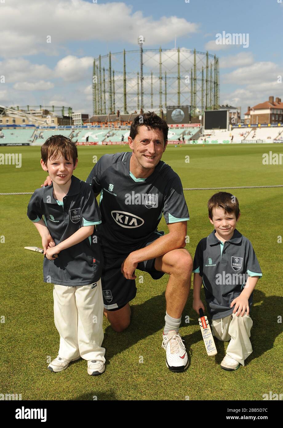 Surrey's Jon Lewis with the match day mascots Stock Photo - Alamy