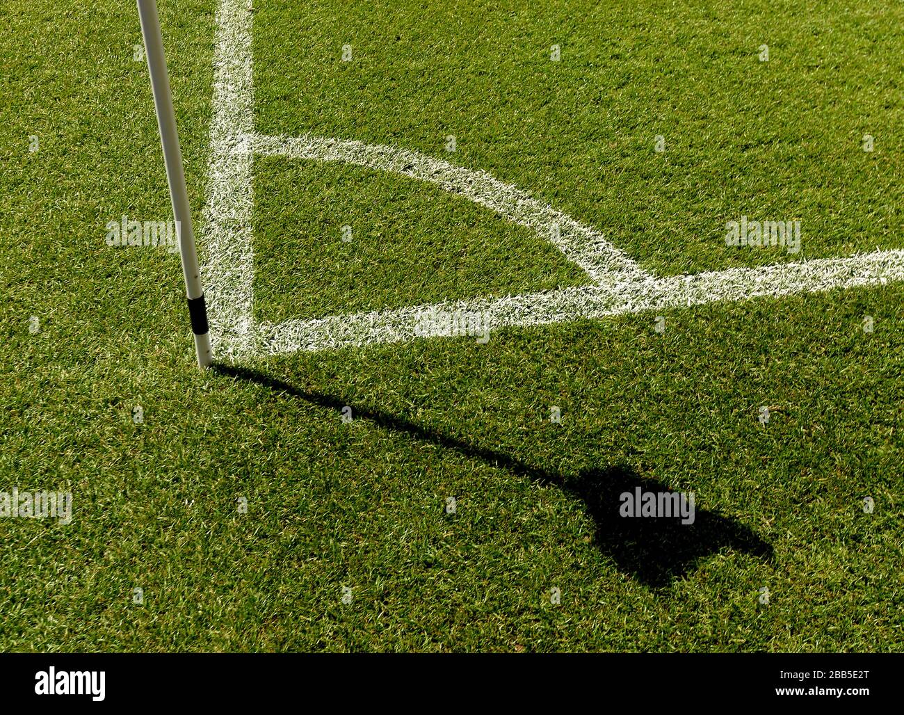General view of corner pitch markings and the shadow of the corner flag ...
