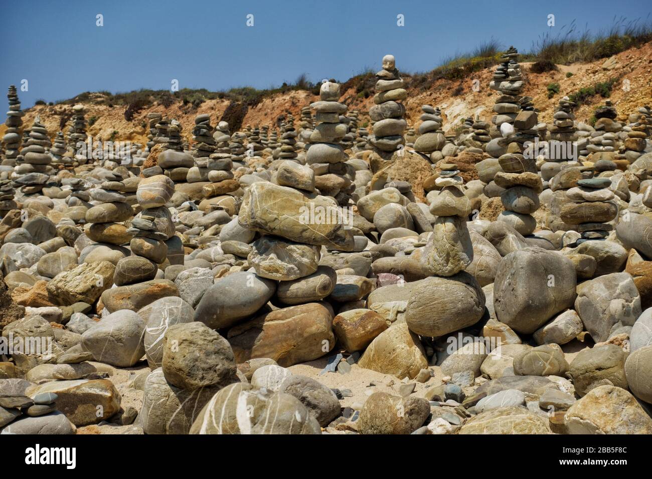 Piles of zen stones covering a big part of beautiful sand beach Stock ...