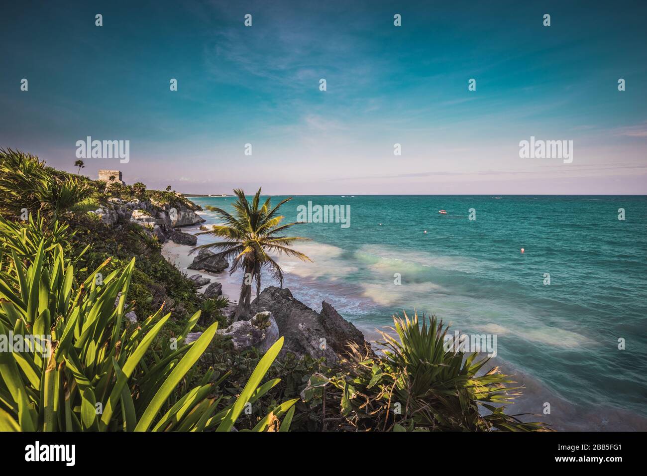 Sunset view at Mayan ruins of Tulum at tropical coast. El Castillo ...