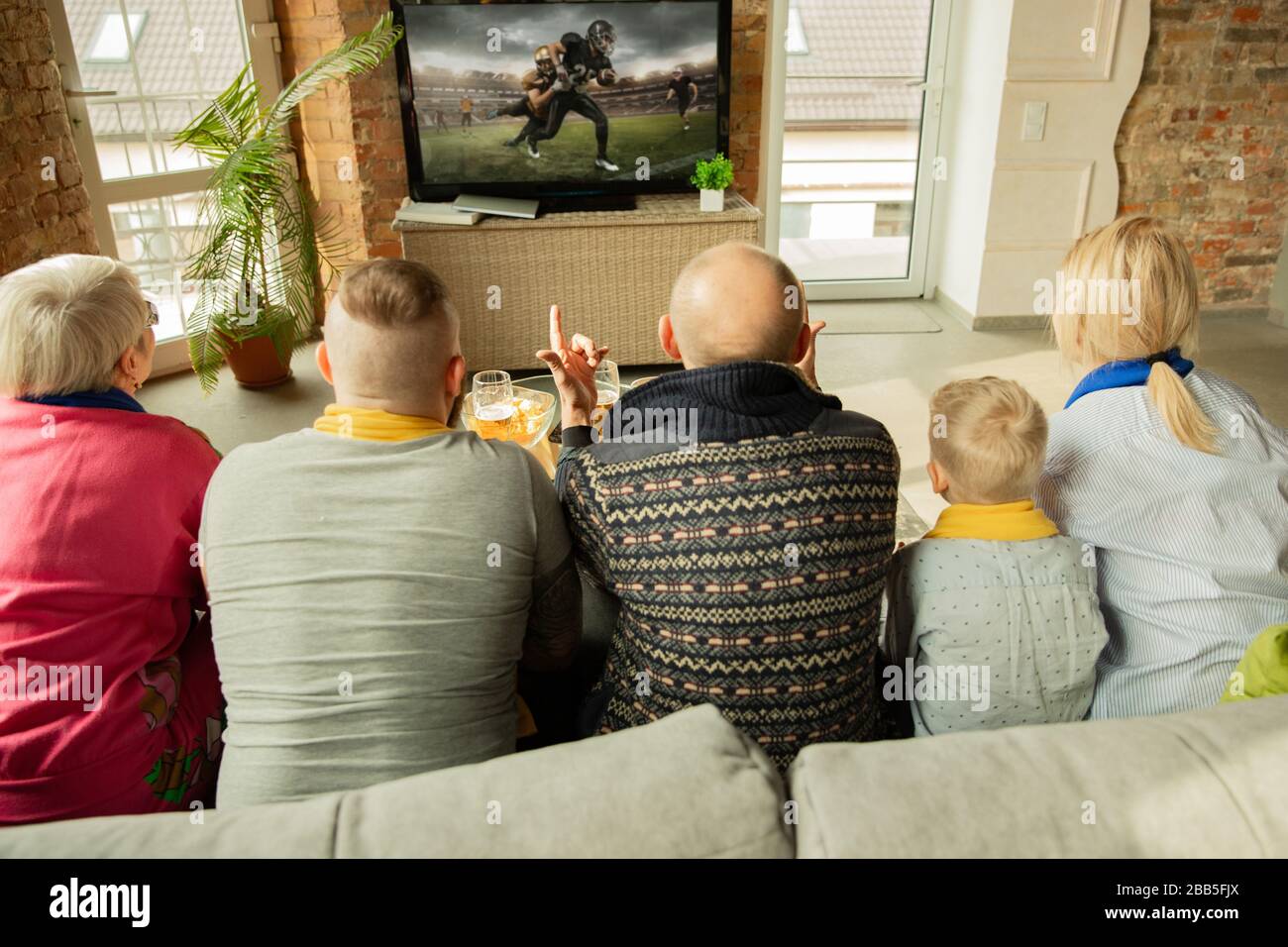 Excited caucasian family watching american football championship, sport ...