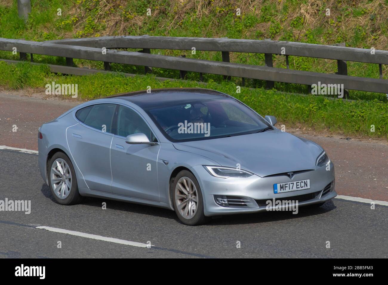 2017 silver Tesla Model S 90D; Vehicular traffic moving vehicles ...