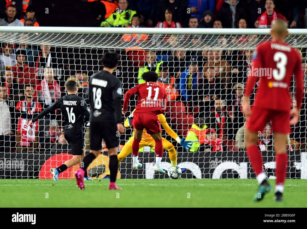 Liverpool's Mohamed Salah (centre) scores his side's third goal of the ...