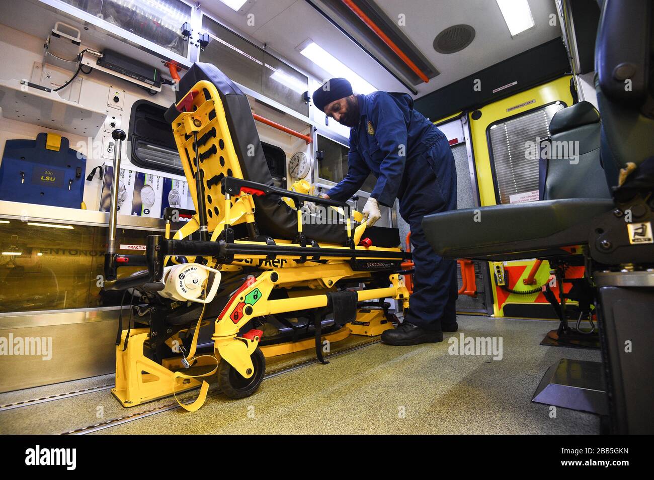 An nhs mechanic checks the fittings inside an ambulance hi-res stock ...
