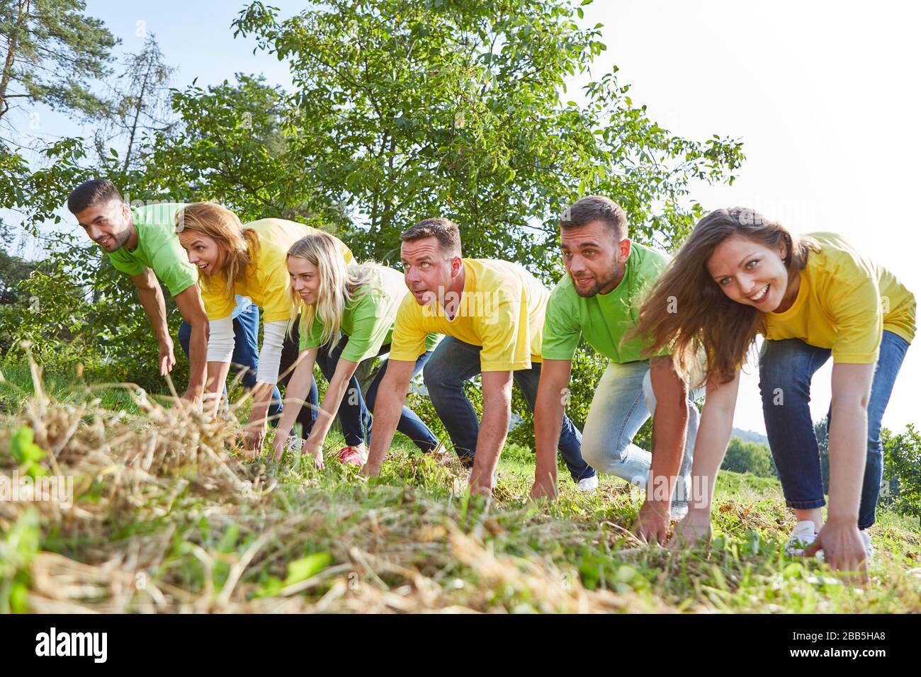 Team group at the start of the race at team building event on a meadow ...