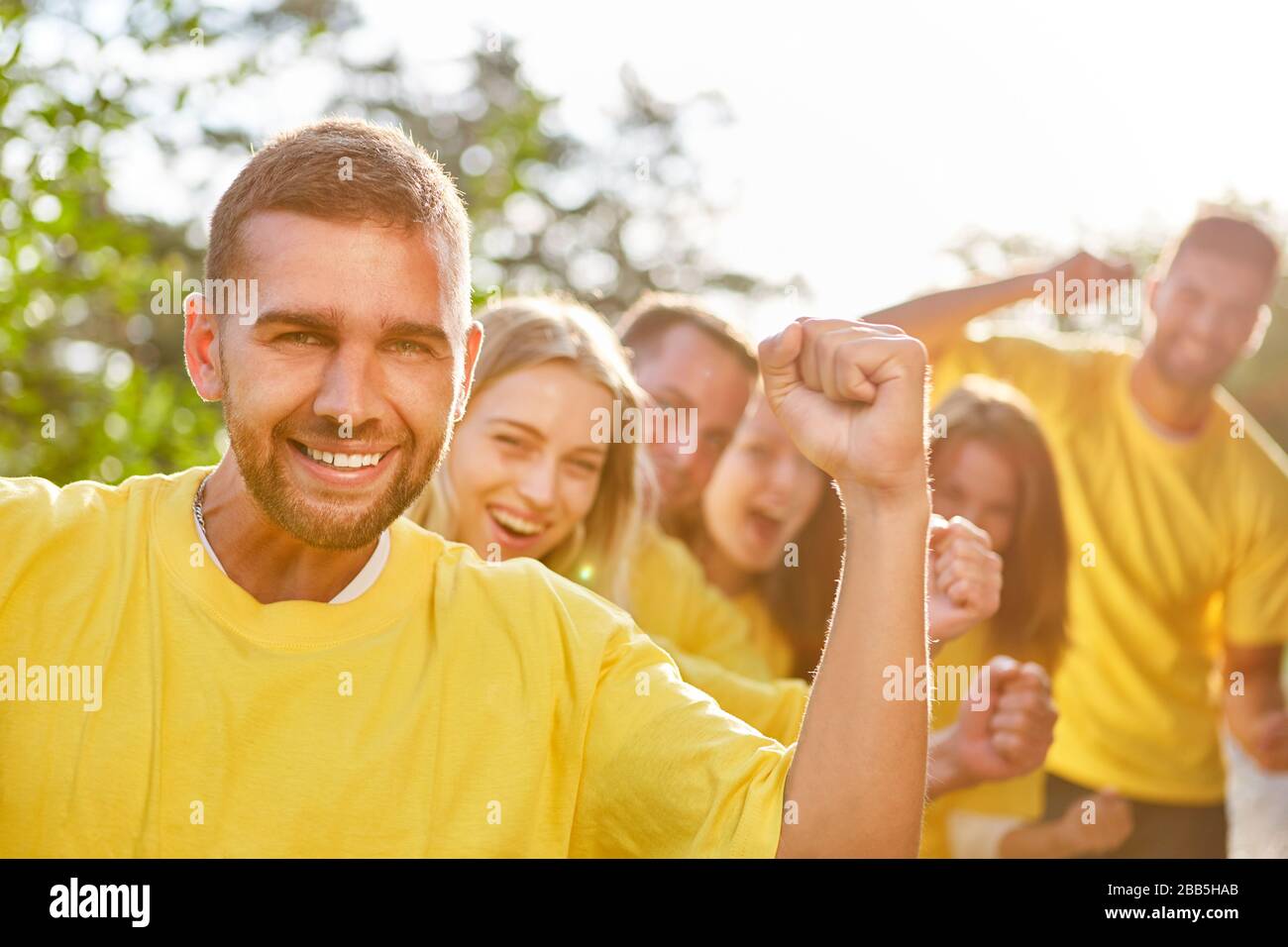 Team building workshop together as a happy group outdoors in nature ...