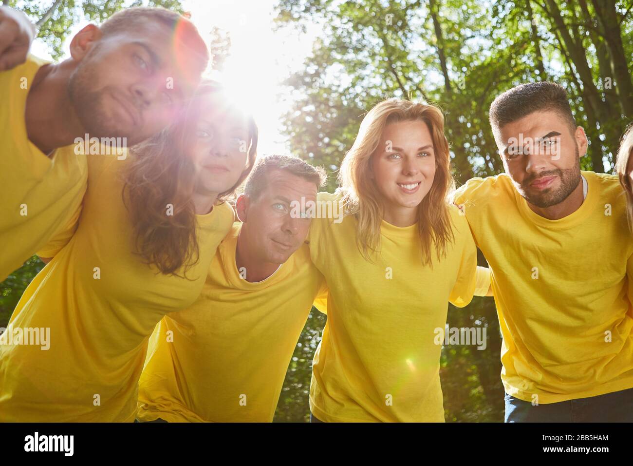 Group makes hug for teamwork and team spirit in nature at a team ...