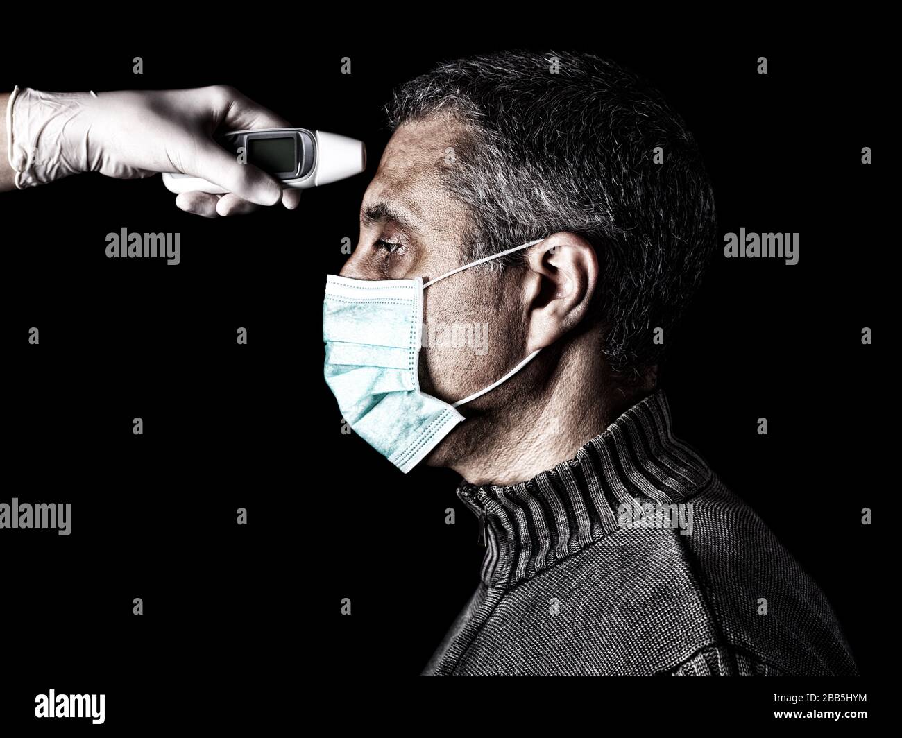 man having the fever measured or taken with digital thermometer by ...