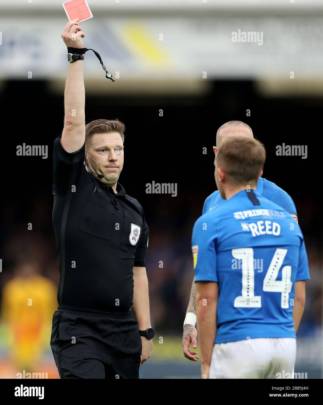 Peterborough United's Louis Reed is shown a red card by referee Micheal ...