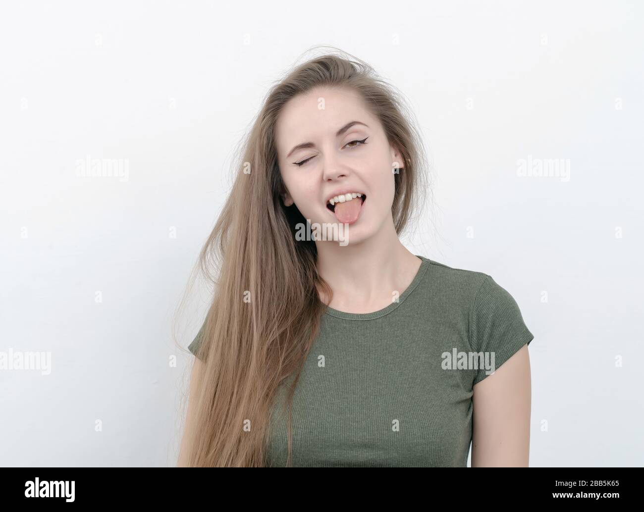 Cheerful ironic girl with long hair smiles at camera Stock Photo - Alamy