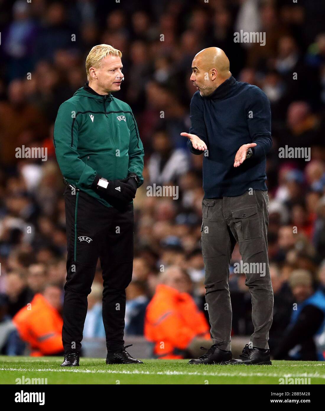 Manchester City manager Pep Guardiola speaks to the fourth official on ...