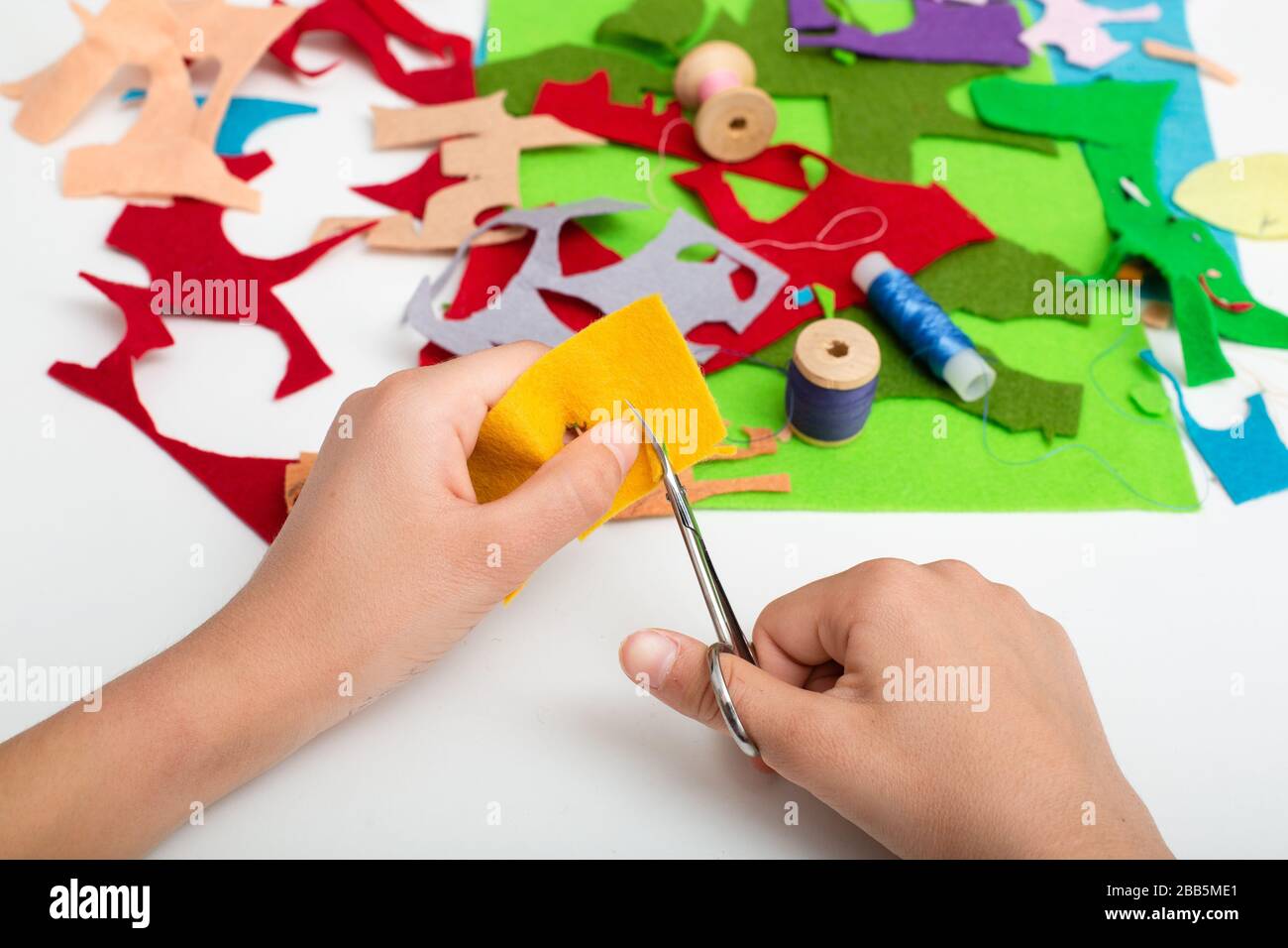 children hands cut color felt with scissors. View from above Stock ...