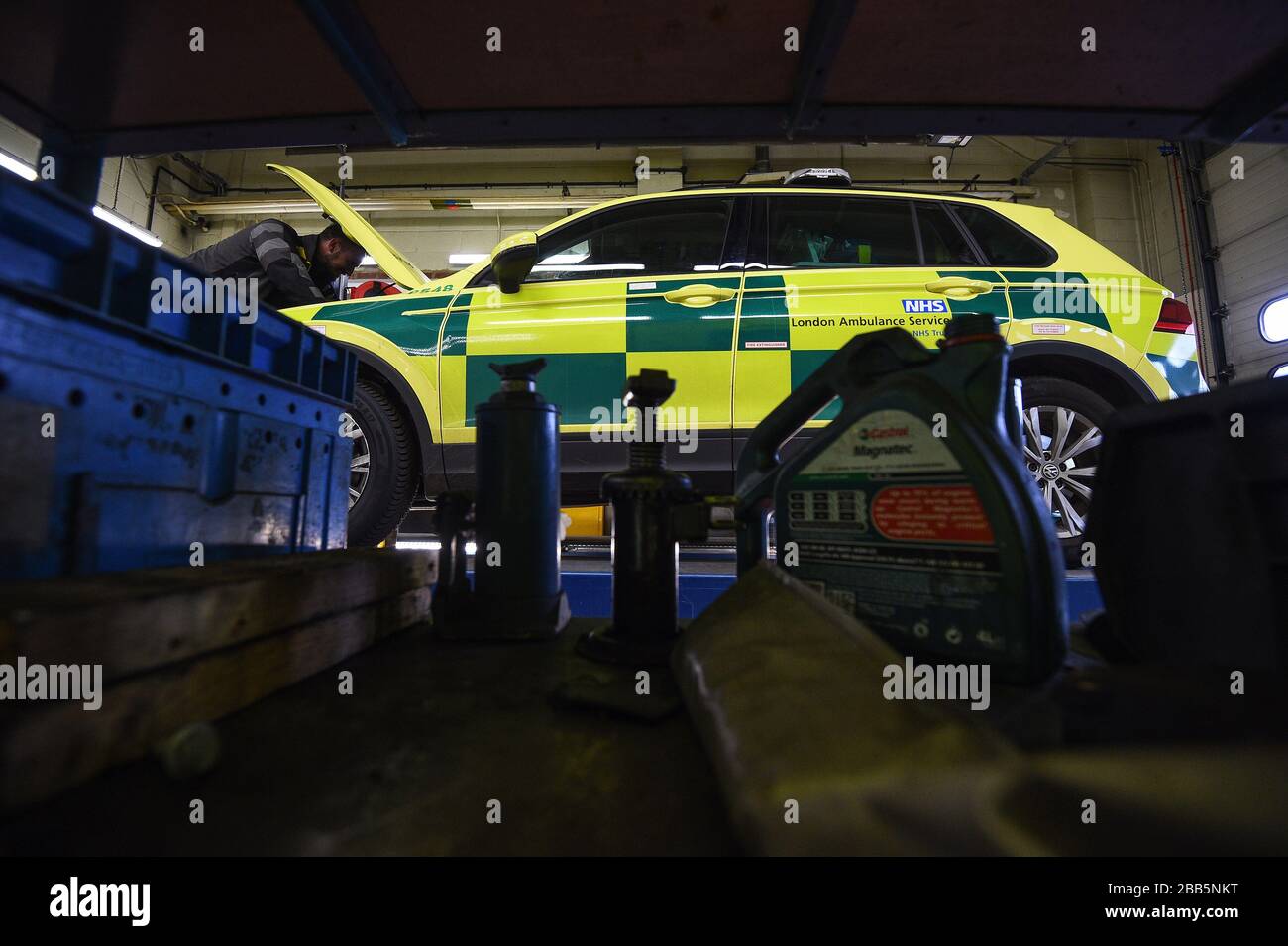 An AA mechanic checks the engine of an ambulance, at the London ...