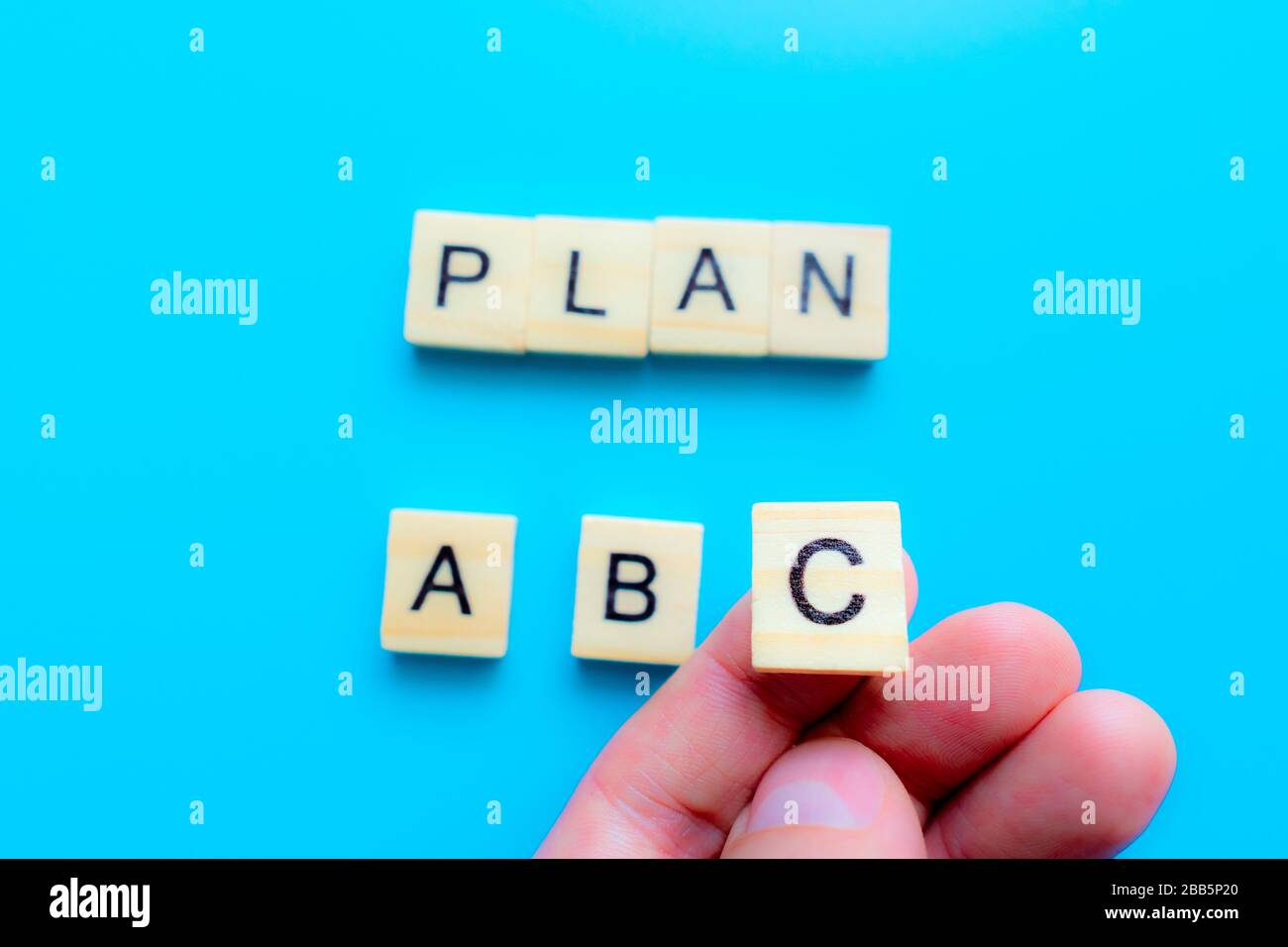 Wooden letters plan a B C, business concept, on blue background, top ...