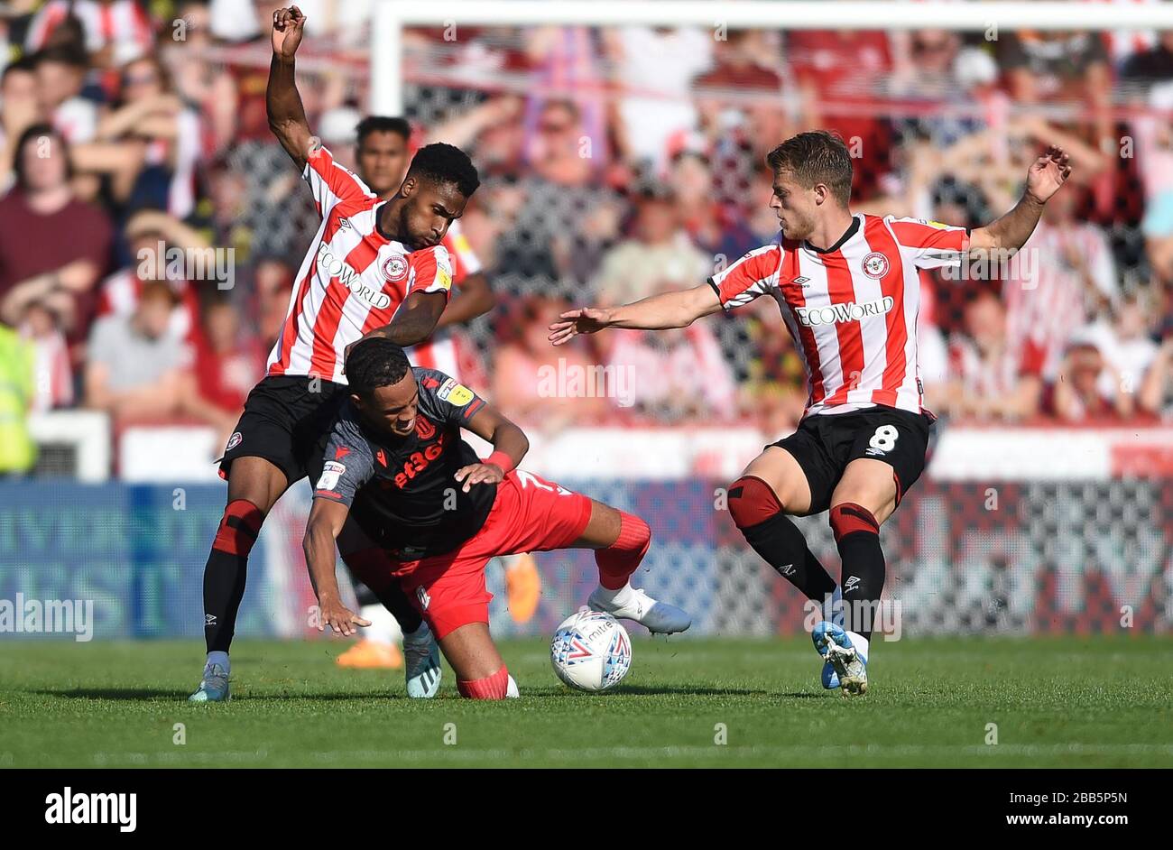 Brentford's Rico Henry (left) and Mathias Jensen combine to stop Stoke ...