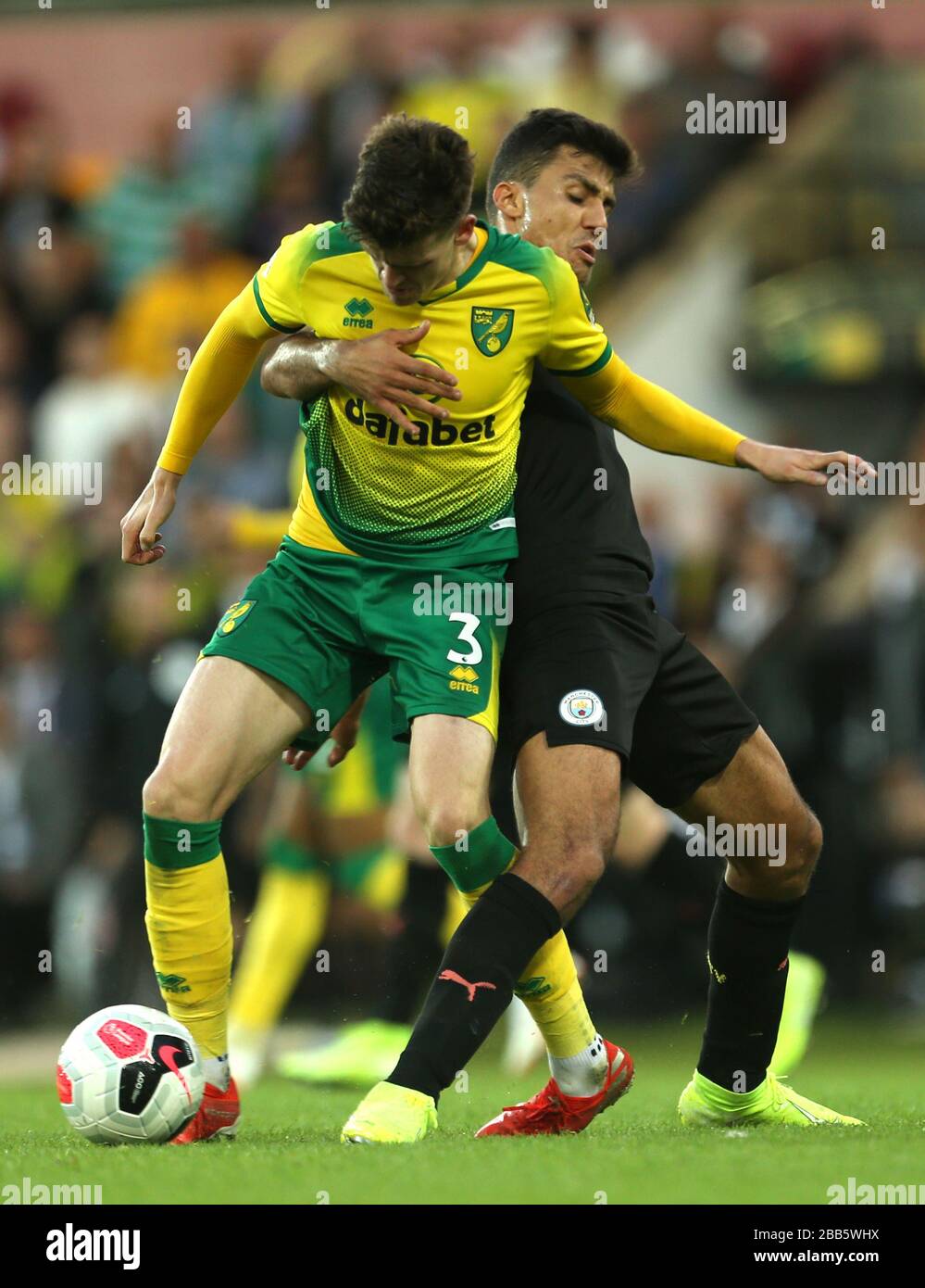 Norwich City's Sam Byram (left) and Manchester City's Rodrigo battle ...