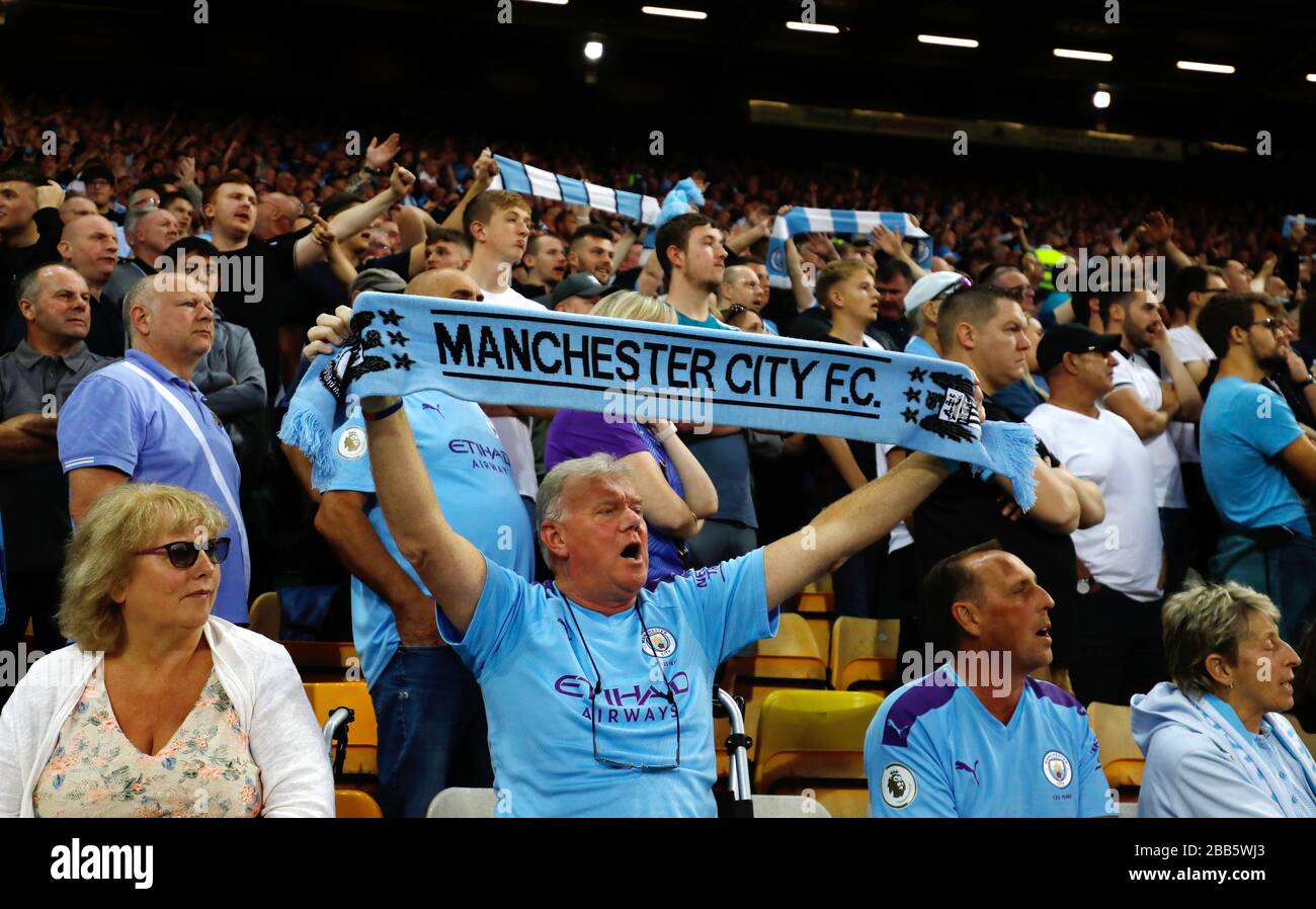 A Manchester City fan in the stands shows his support Stock Photo - Alamy