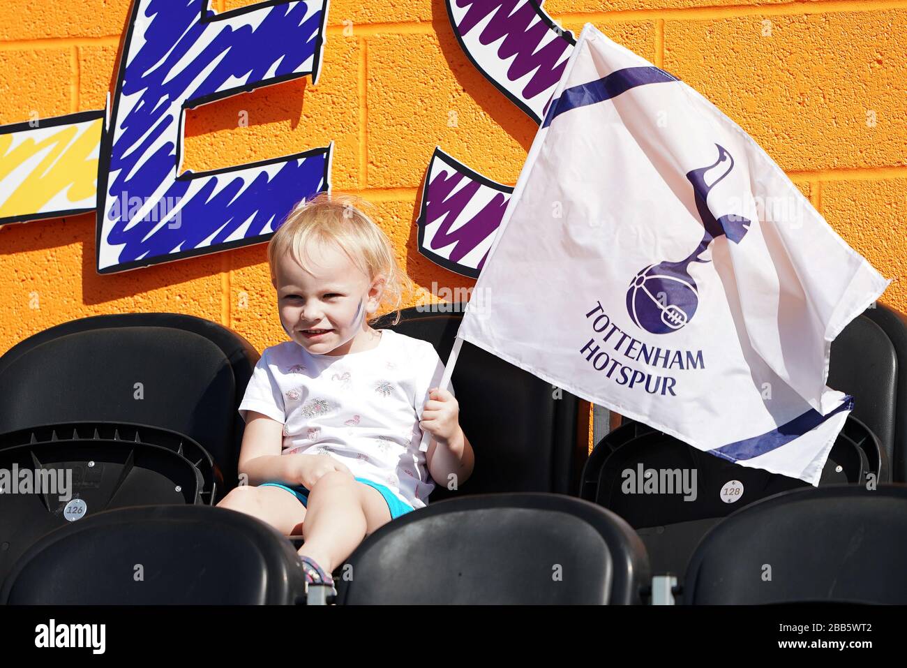 A young Tottenham fan waves her flag during the game Stock Photo - Alamy