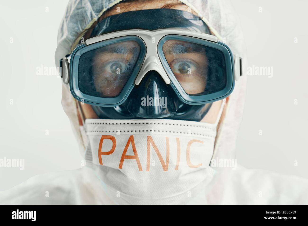 Scared doctor or virologist bio suit and protective mask with the ...