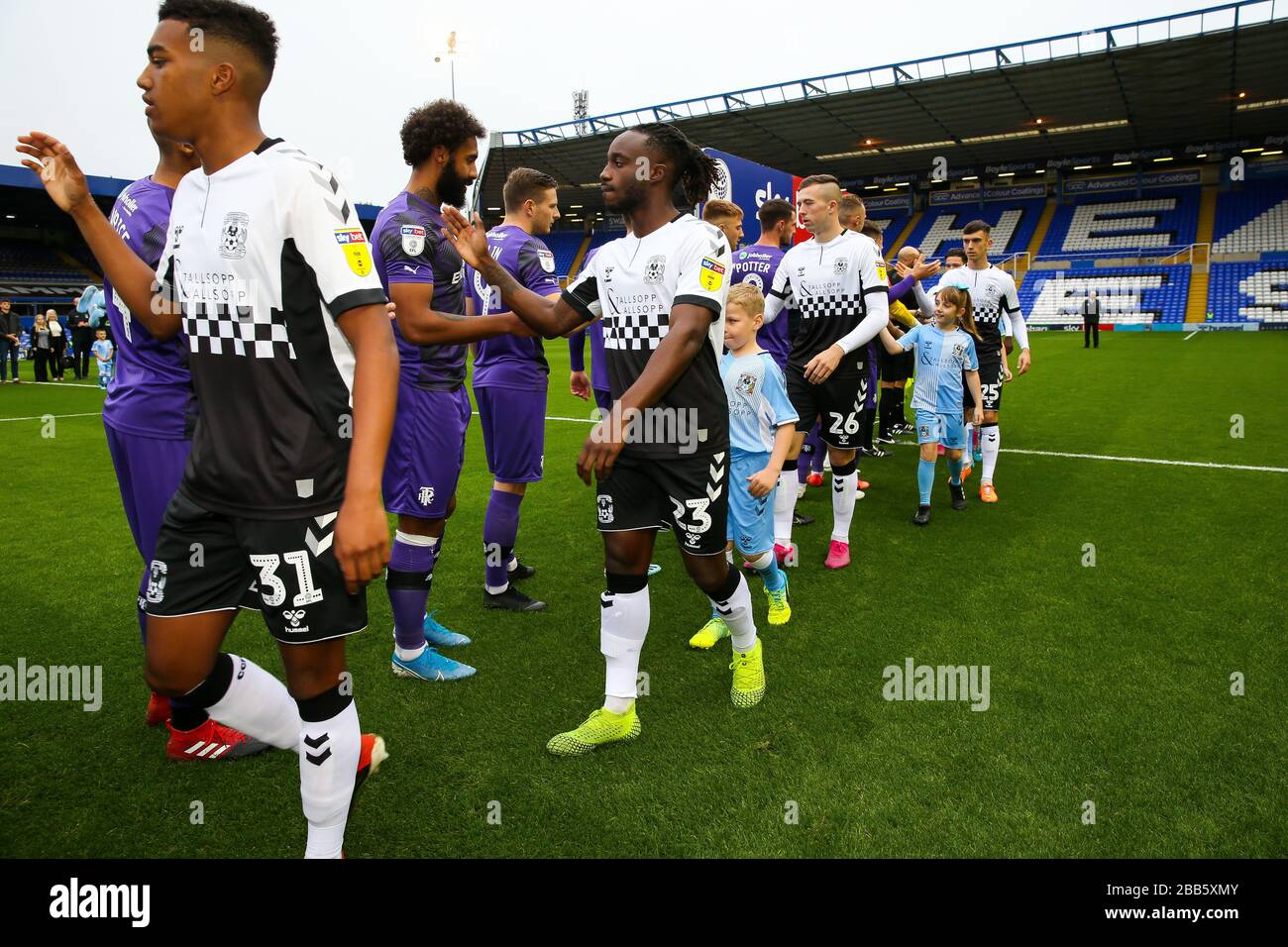 Coventry City's players and mascots shake hand with the Tranmere Rovers ...